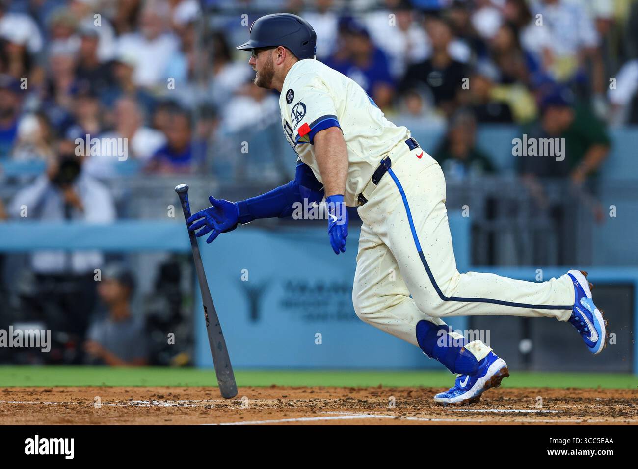 Los Angeles Dodgers' Max Muncy drops his bat after hitting a single ...