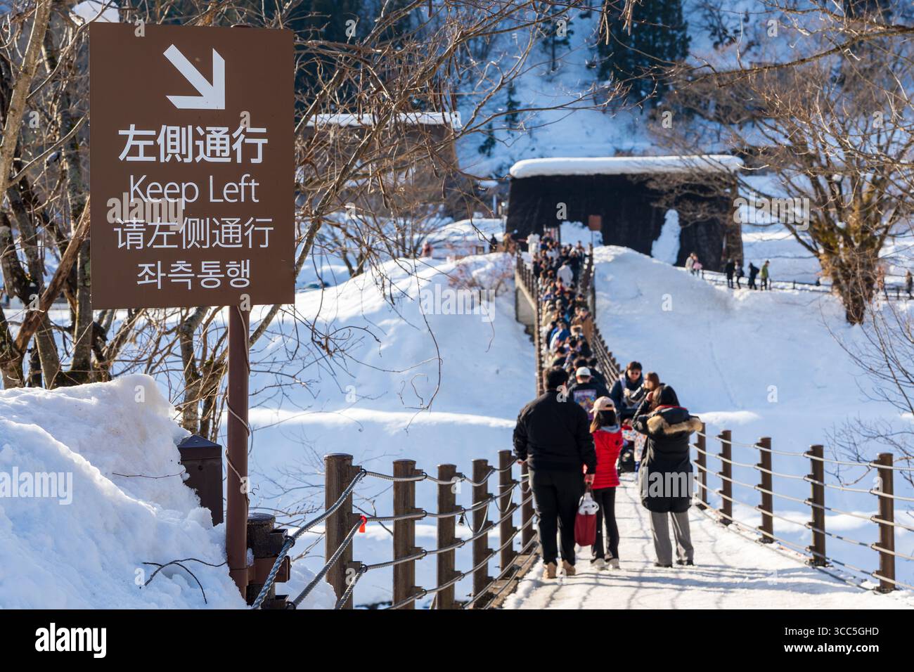 Tourists cross the Deai Bridge (Meeting Bridge), the main pedestrian ...