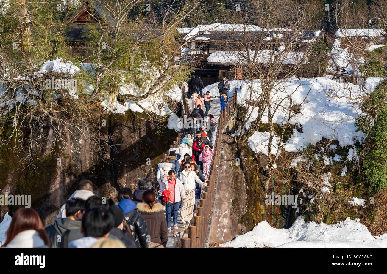Tourists cross the Deai Bridge (Meeting Bridge), the main pedestrian ...