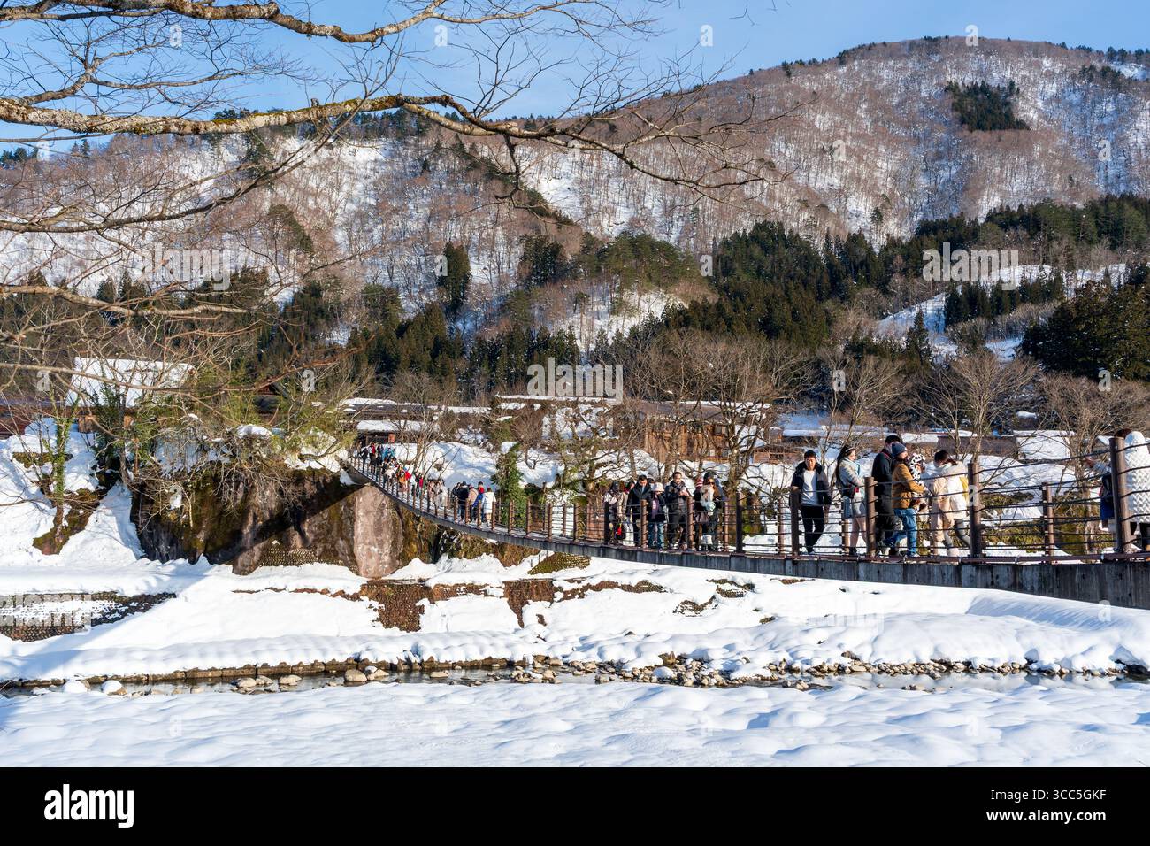 Tourists cross the Deai Bridge (Meeting Bridge), the main pedestrian ...
