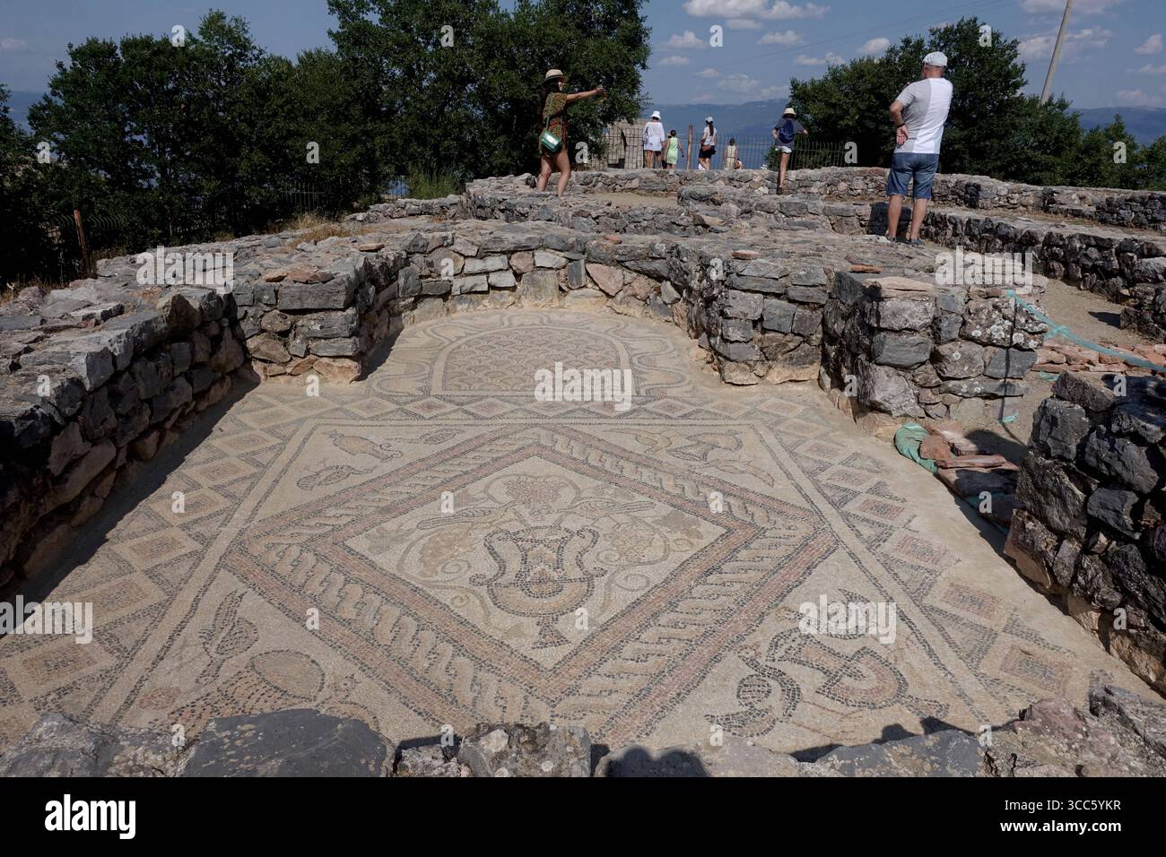 Tourists visit the IV-V century mosaic at the ruins of a Paleochristian ...