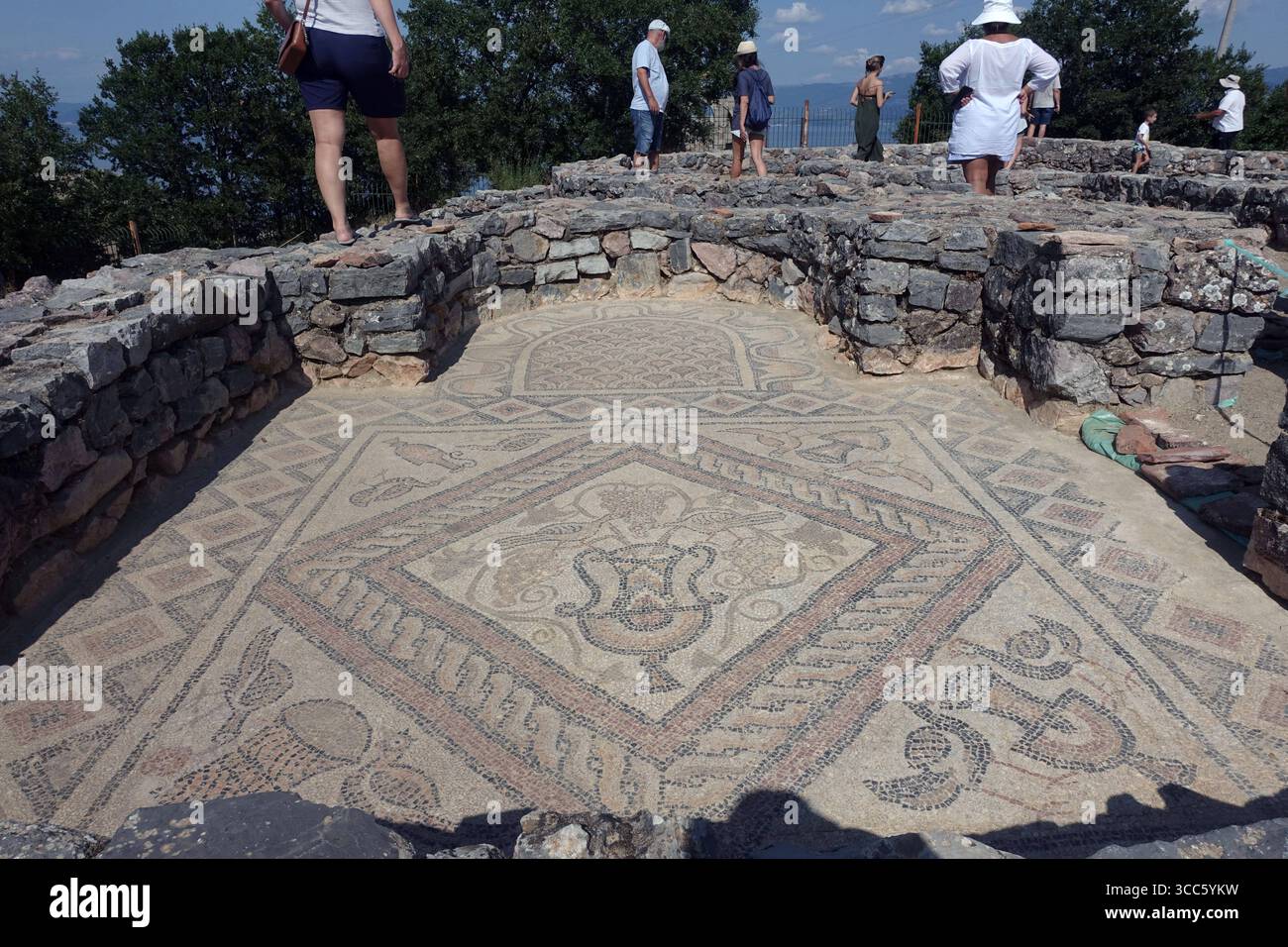 Tourists visit the IV-V century mosaic at the ruins of a Paleochristian ...