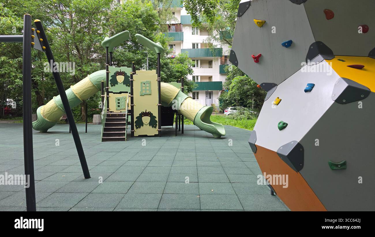 Colorful playground with slide, swing, and climbing wall promotes ...