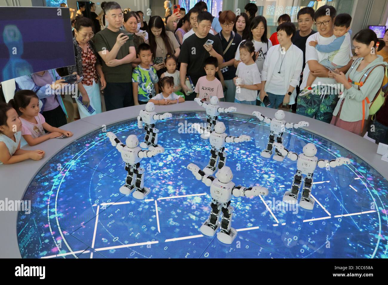 BEIJING, CHINA - AUGUST 9, 2025 - Viewers watch Alpha Dancing Robot at Robot Mall, the world's ...