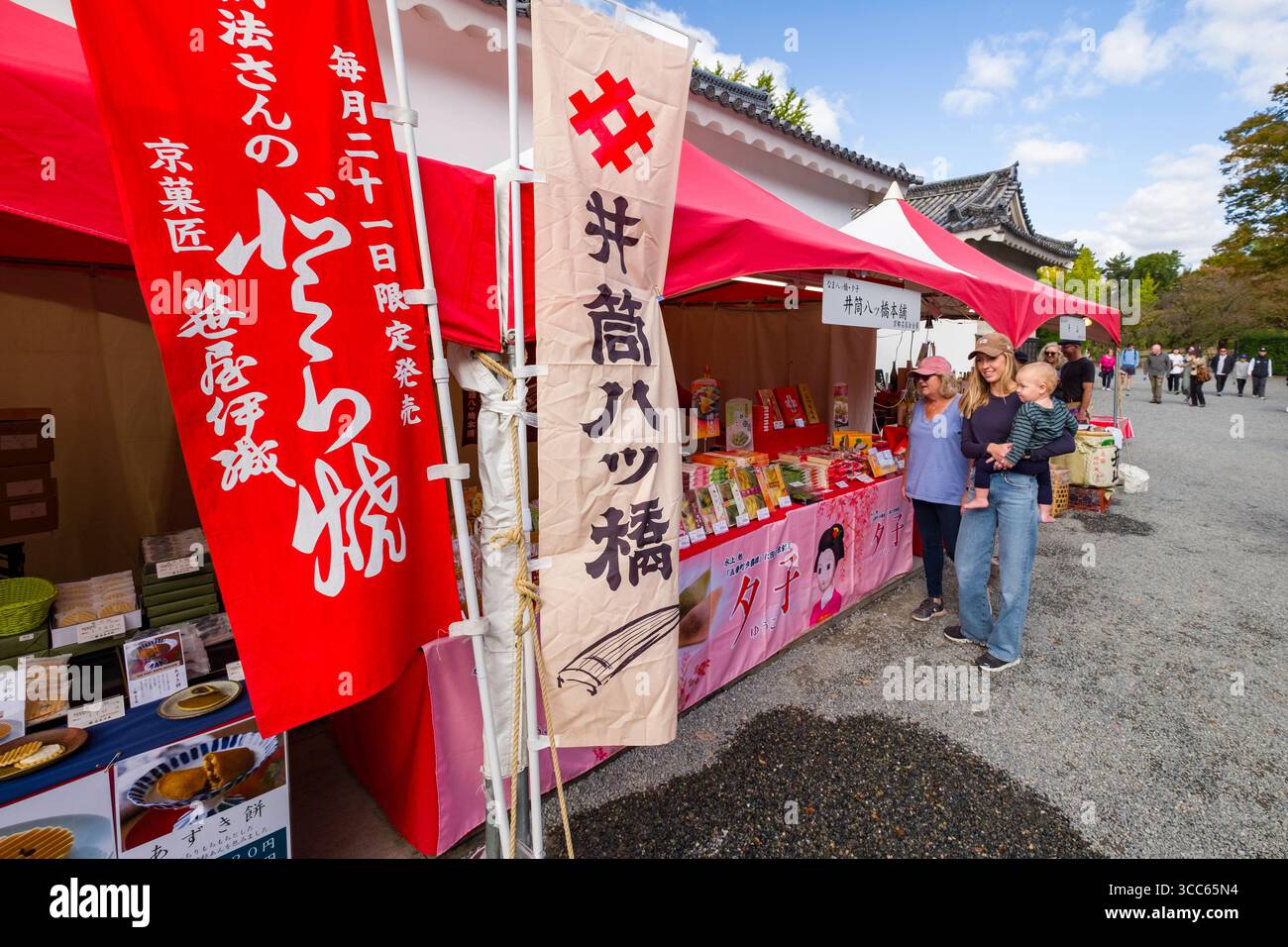 A vibrant Japanese street market with colorful tents and banners ...