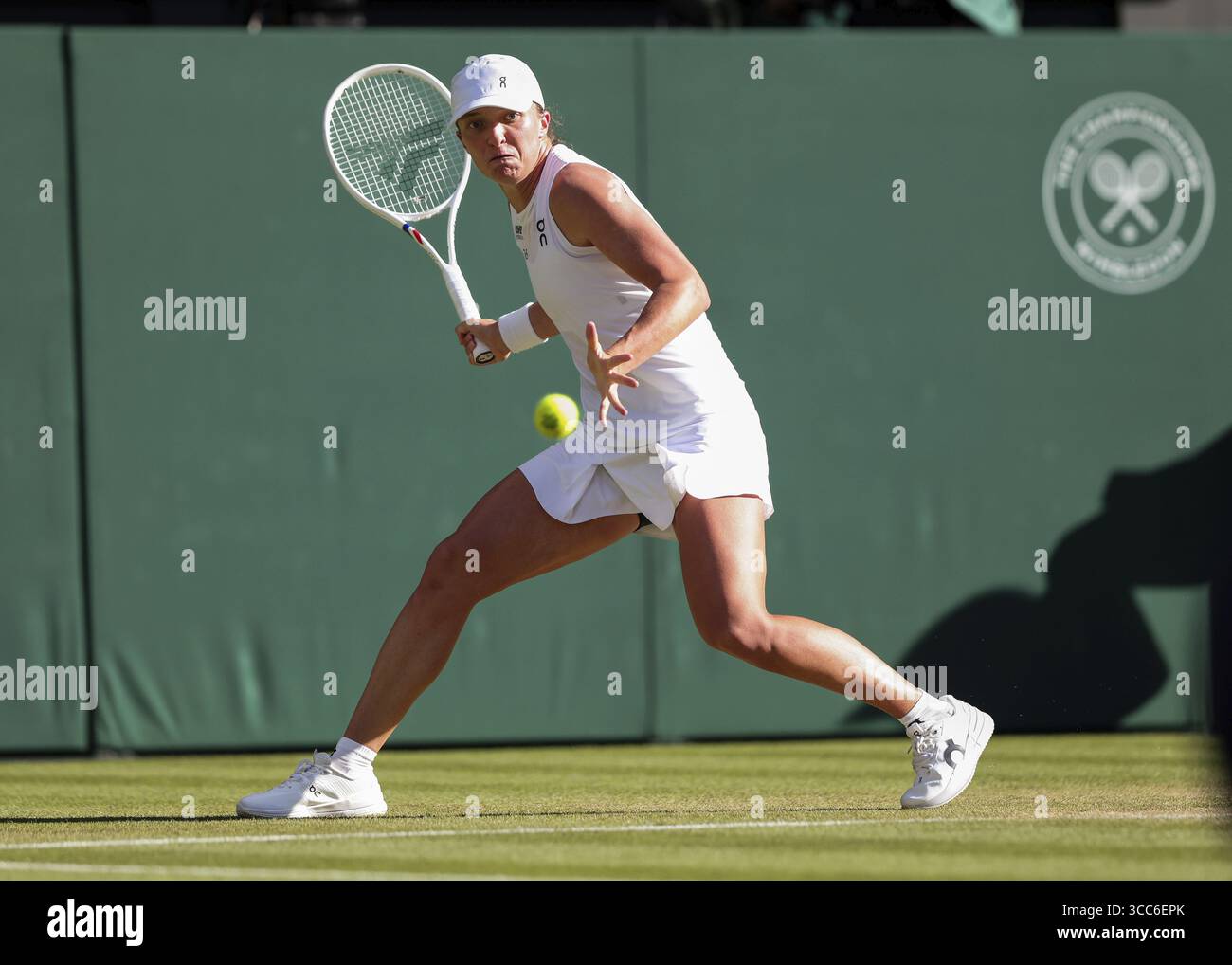 Polish tennis player Iga Swiatek in action at the 2025 Wimbledon ...