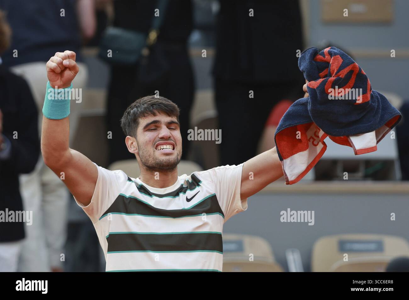 Spanish tennis player Carlos Alcaraz raising his arms after winning the ...