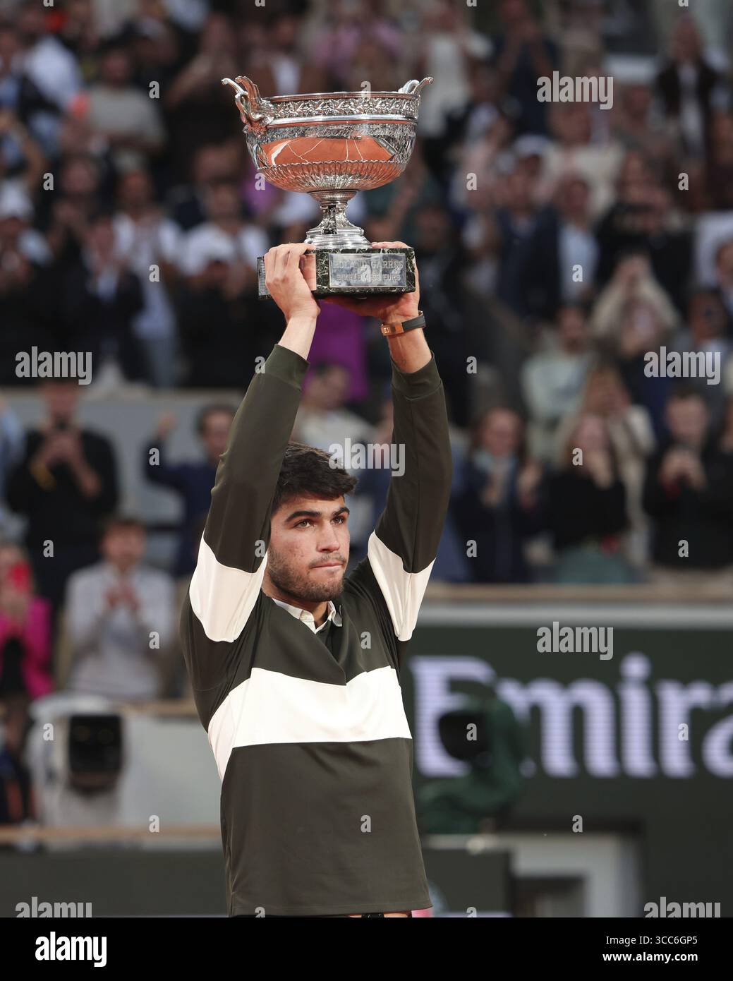 French Open 2025 winner Carlos Alcaraz holding the trophy up in the air ...