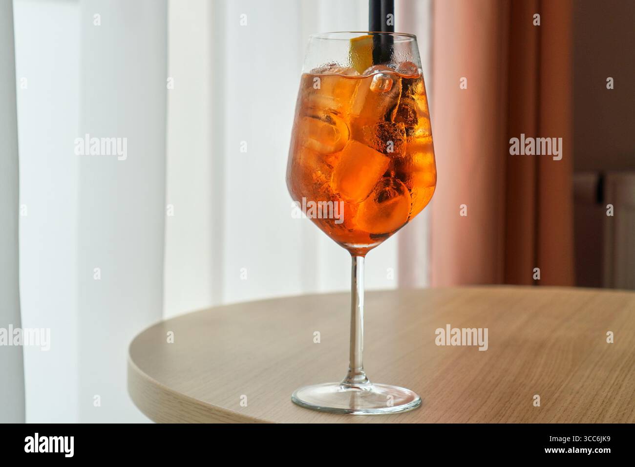 Chilled Aperol spritz cocktail on a table with ice cubes and orange ...