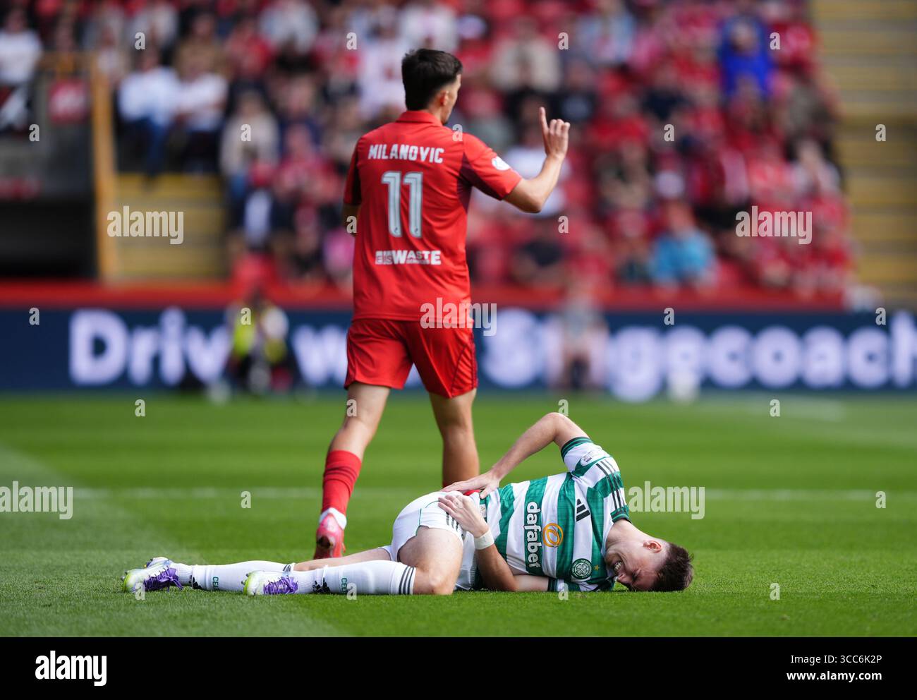 Celtic's Kieran Tierney appears in pain after a challenge from Aberdeen ...
