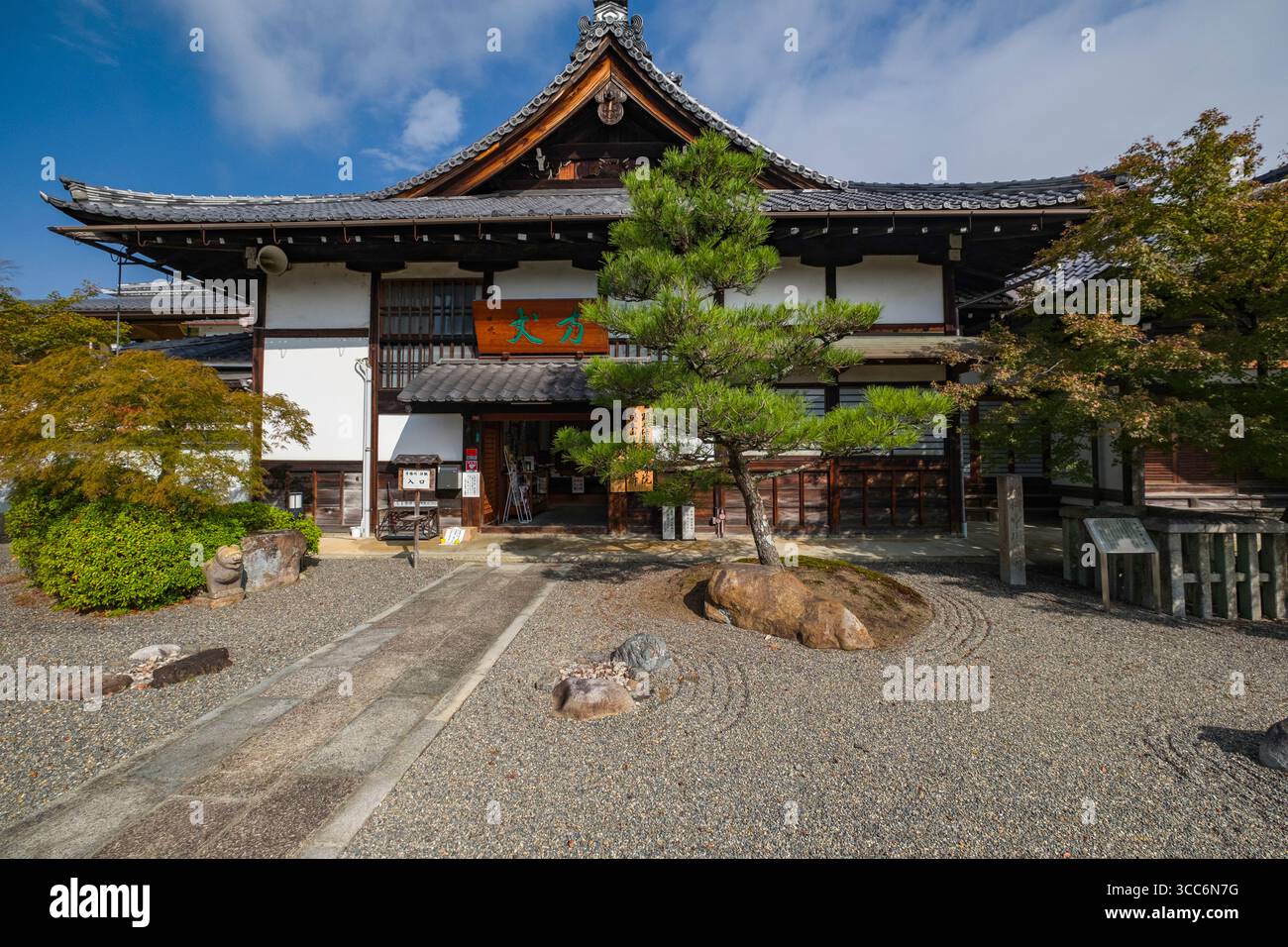 A tranquil scene of a traditional Japanese temple surrounded by a ...