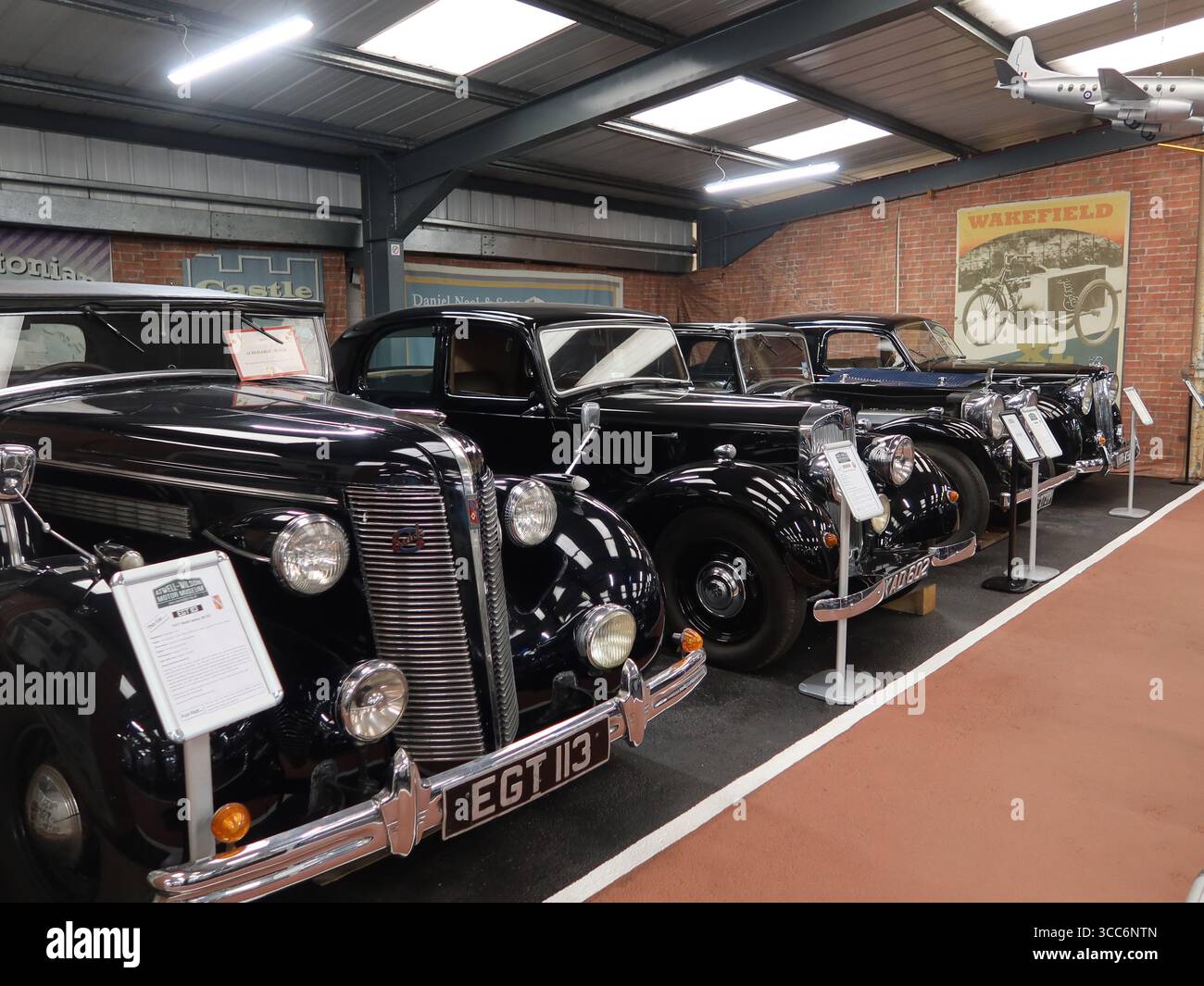 A row of black heritage cars on display at the Atwell-Wilson Motoring ...