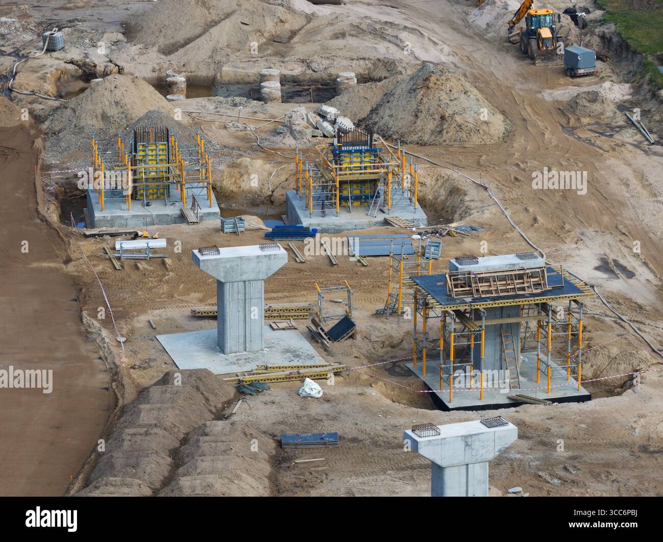 Road Junction Construction Site with Concrete Pillars and Machinery ...