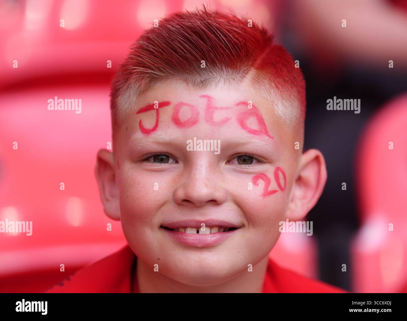 A Liverpool fan with a face paint tribute to the late Diogo Jota ahead ...