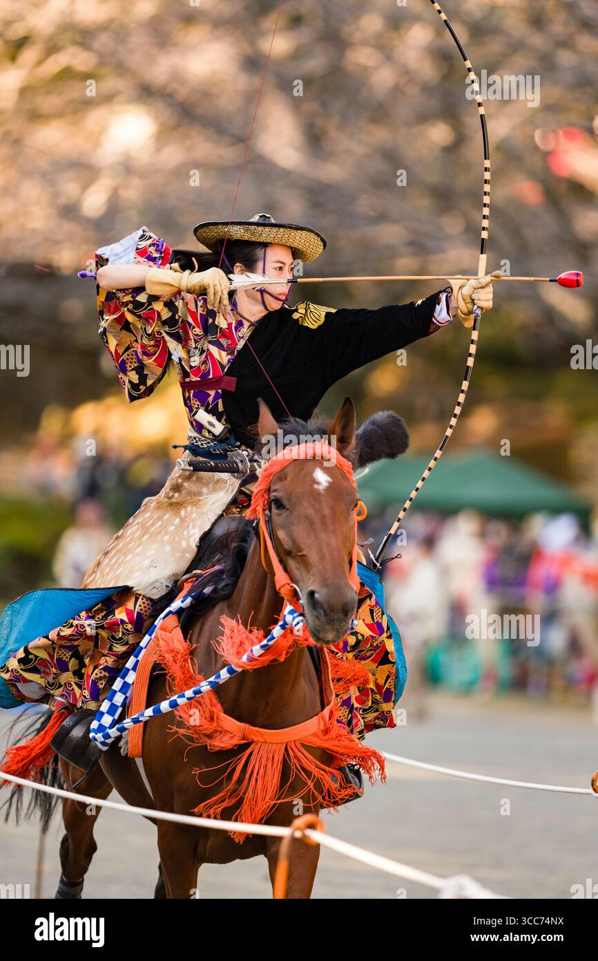 A skilled archer in traditional Japanese attire is seen performing ...