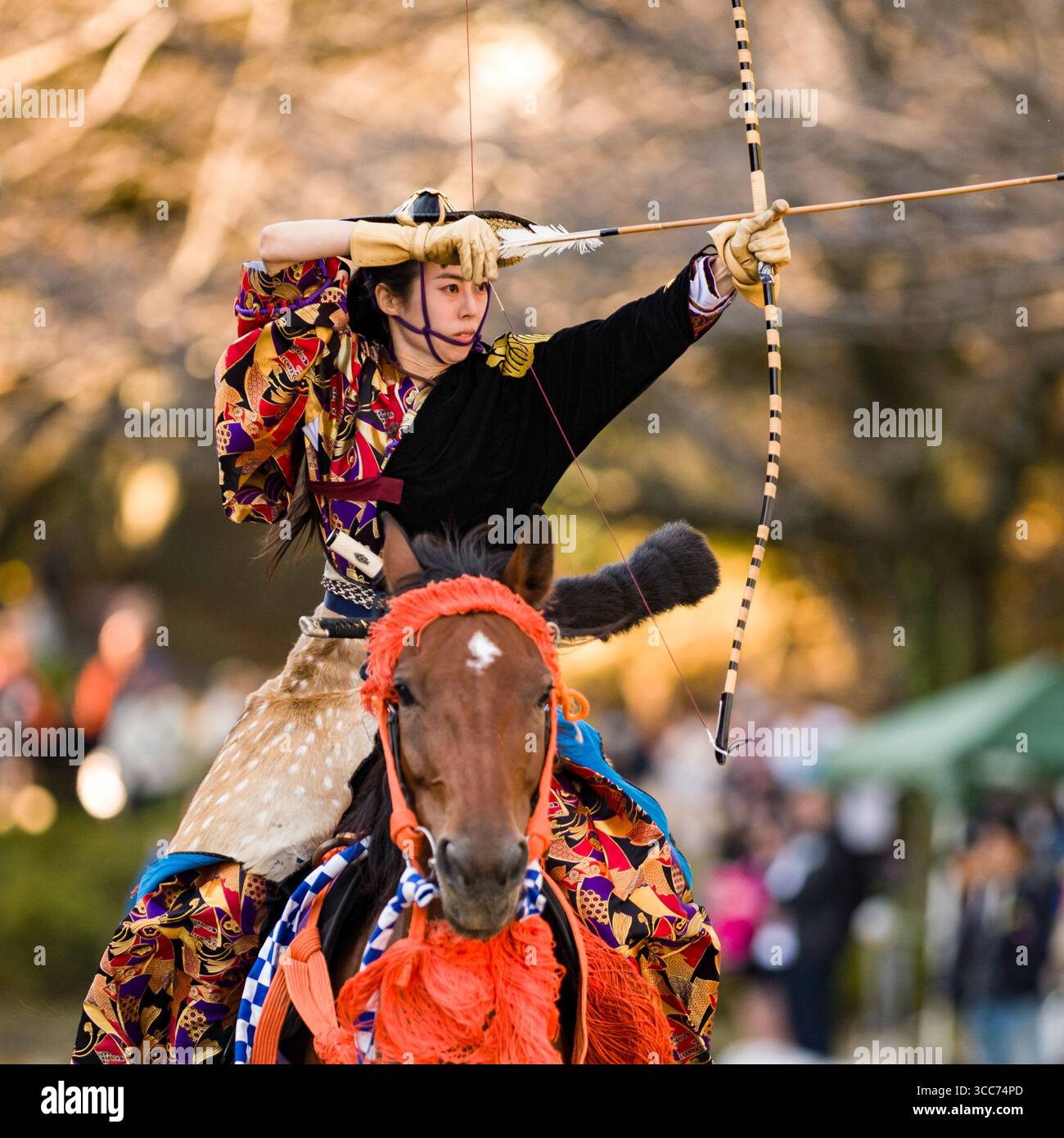 A skilled archer in colorful traditional attire performs Yabusame, an ...