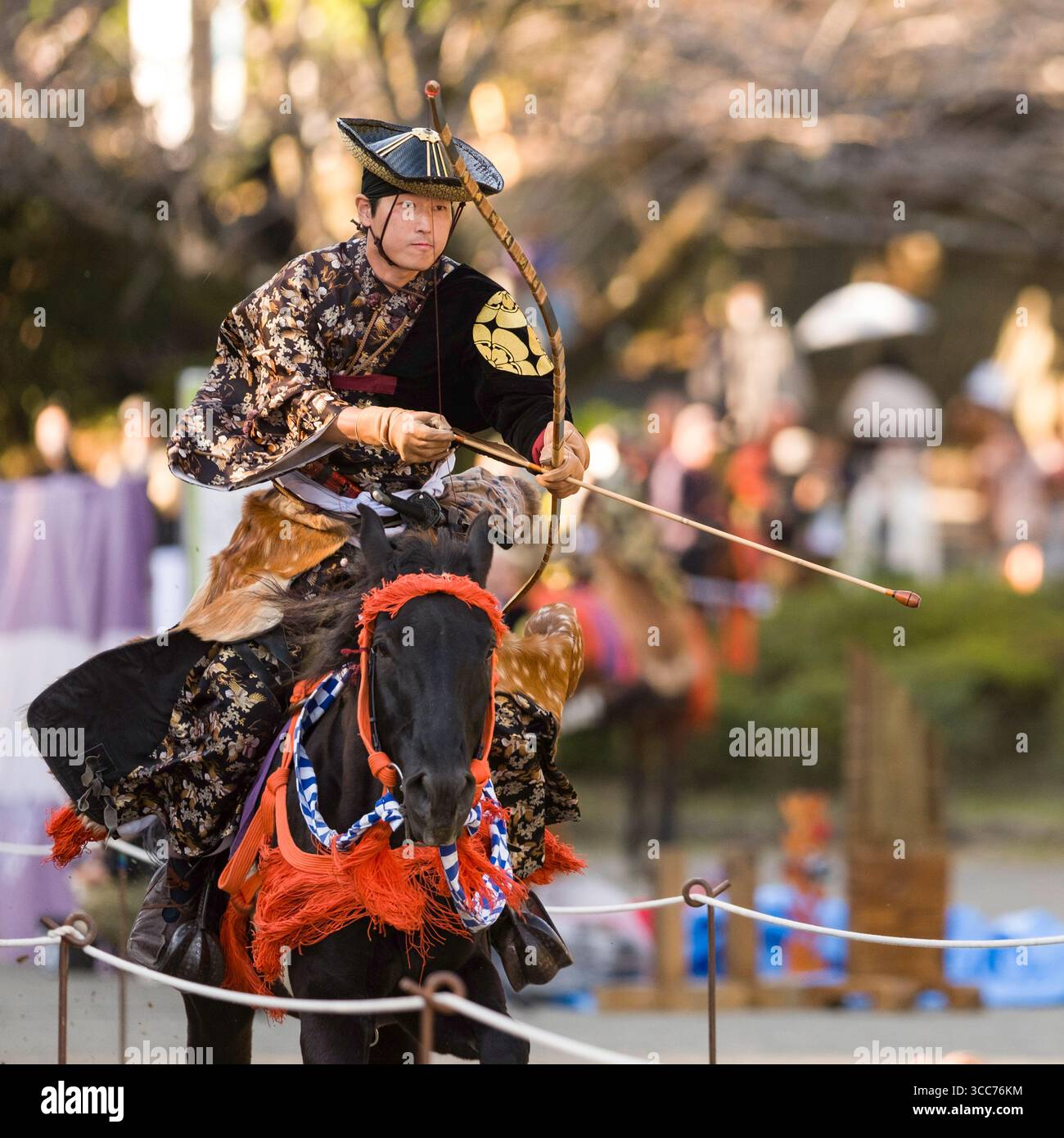 A skilled Japanese archer in traditional attire performs mounted ...