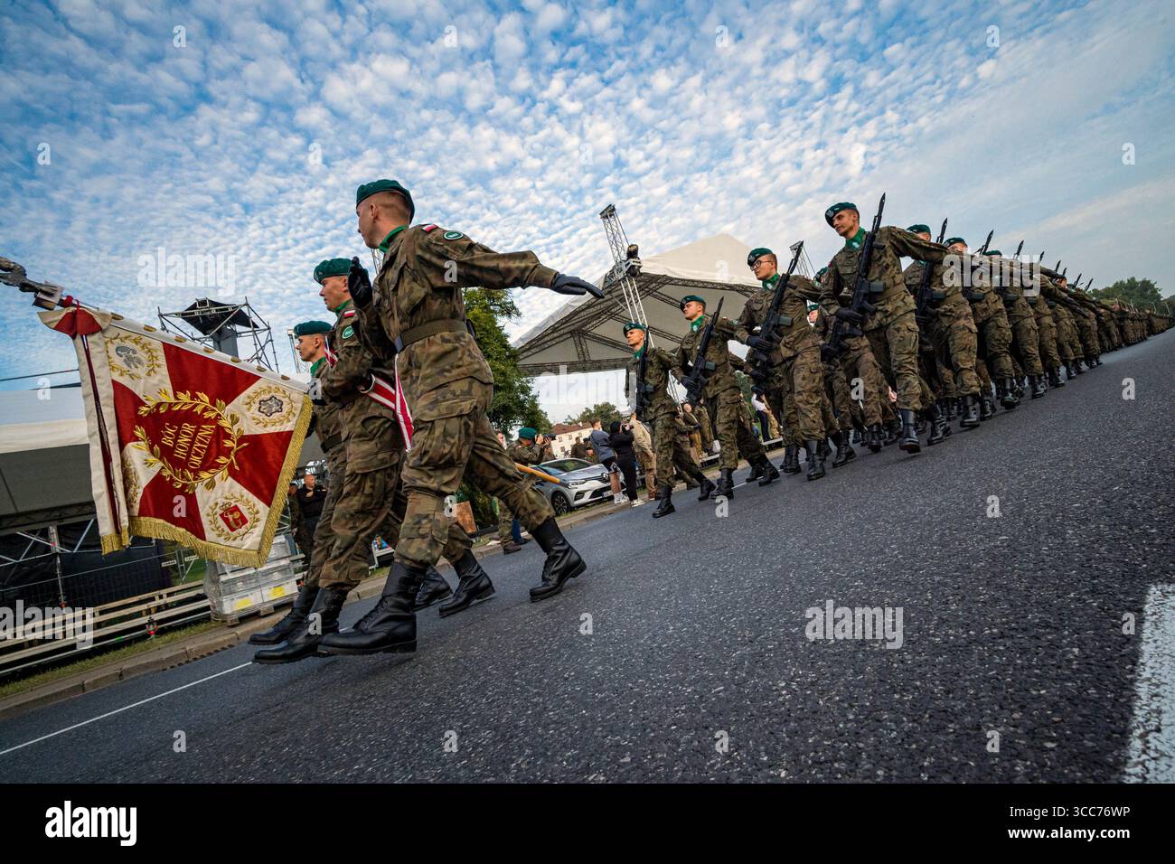 Soldiers march past the viewing platform with a flag bearing the Polish ...