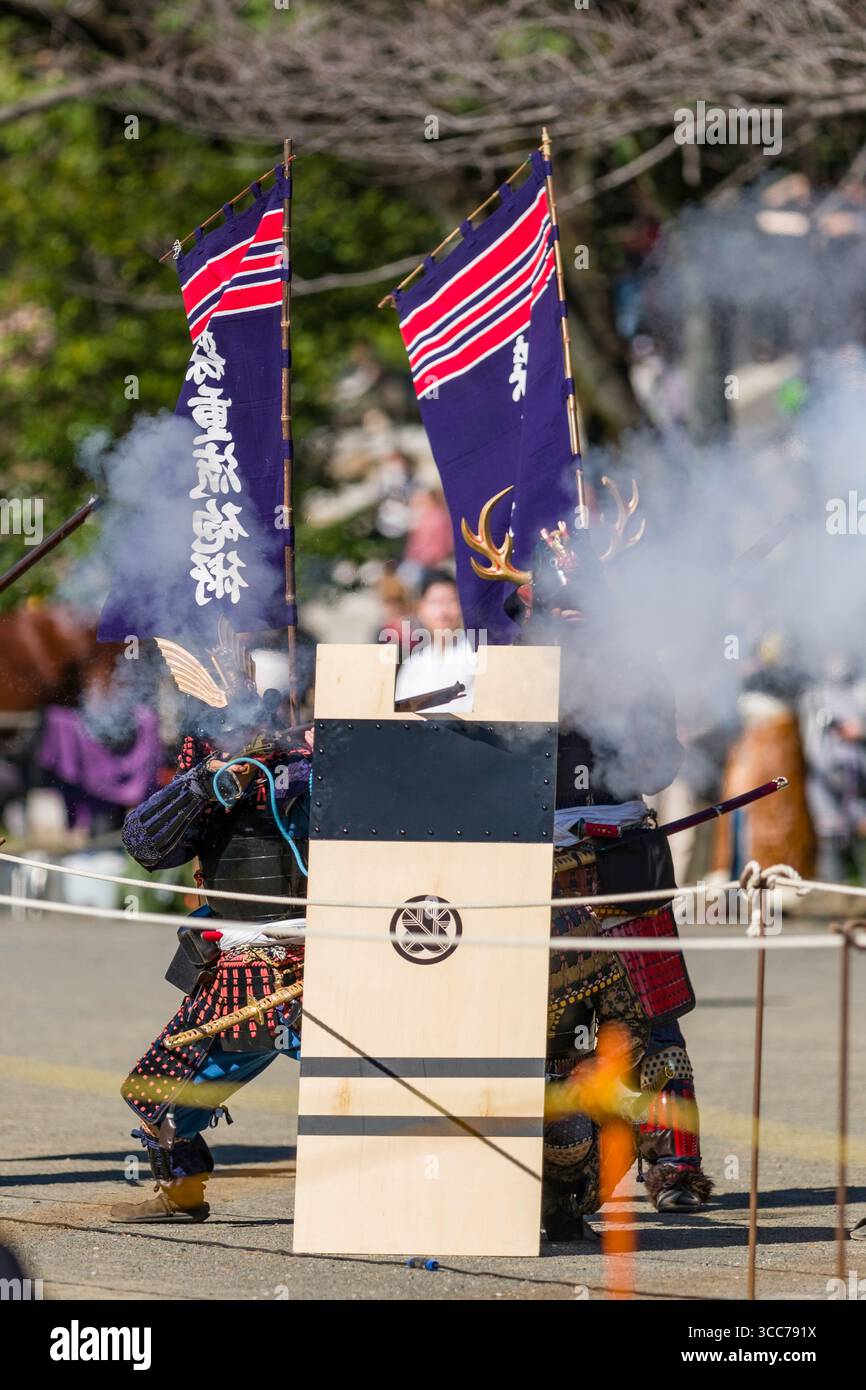 Two samurai warriors in traditional armor stand behind a symbolic ...