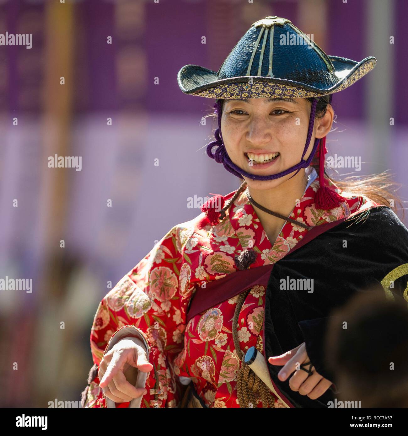 Woman dressed in feudal period archer attire before the start of the Machida Jidai Festival ...