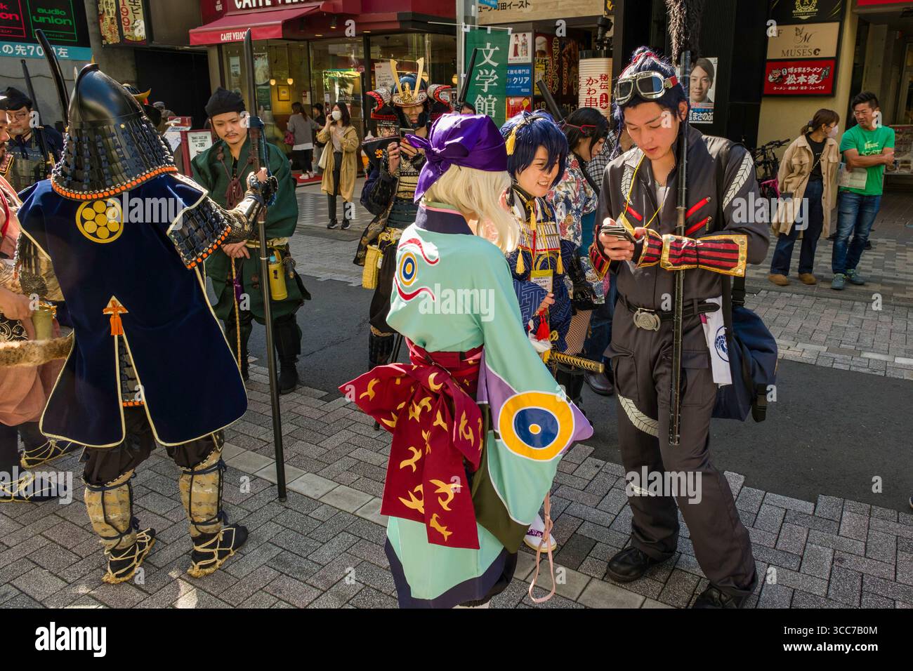 People dressed in cosplay costumes waiting for the start of the Machida Jidai Festival ...