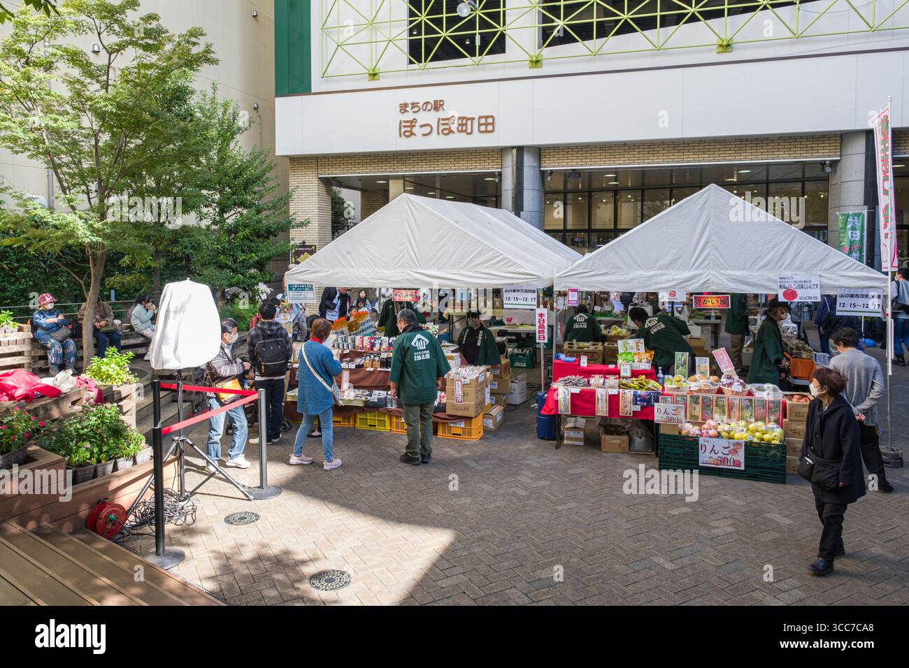 Various items for sale from vendors under white tarp shelters in ...