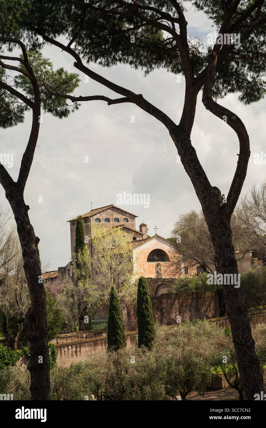 Scenic view of ancient Roman ruins surrounded by lush trees in a serene ...