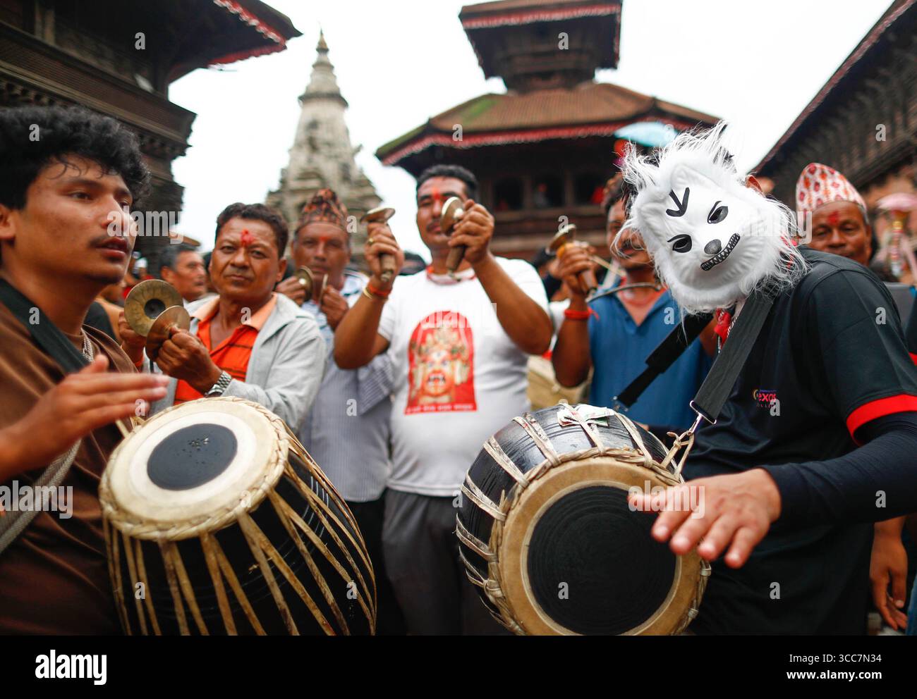 Devotees play traditional drums during the Gai Jatra festival ...