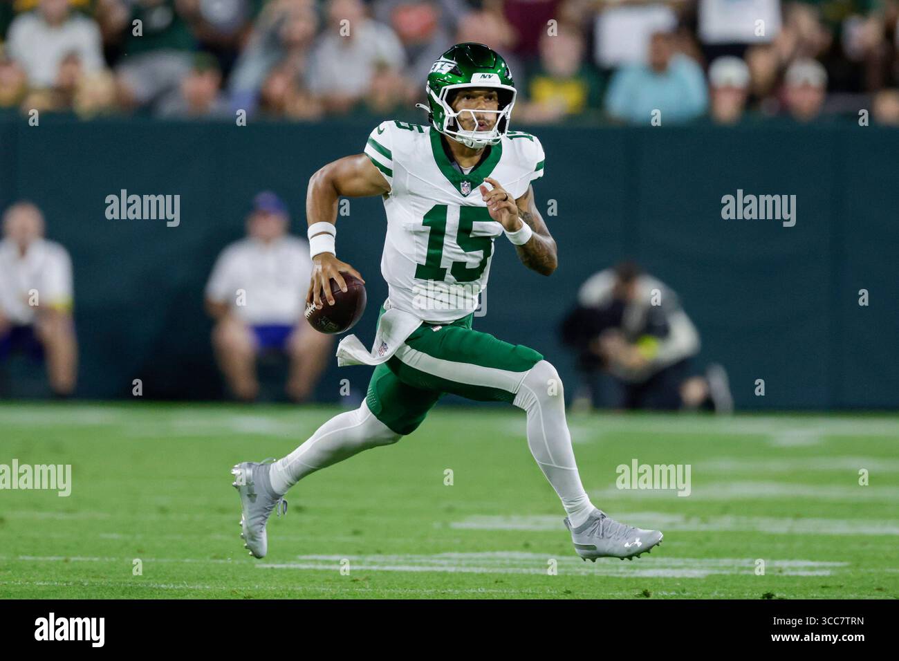 New York Jets quarterback Adrian Martinez (15) scrambles out of the ...