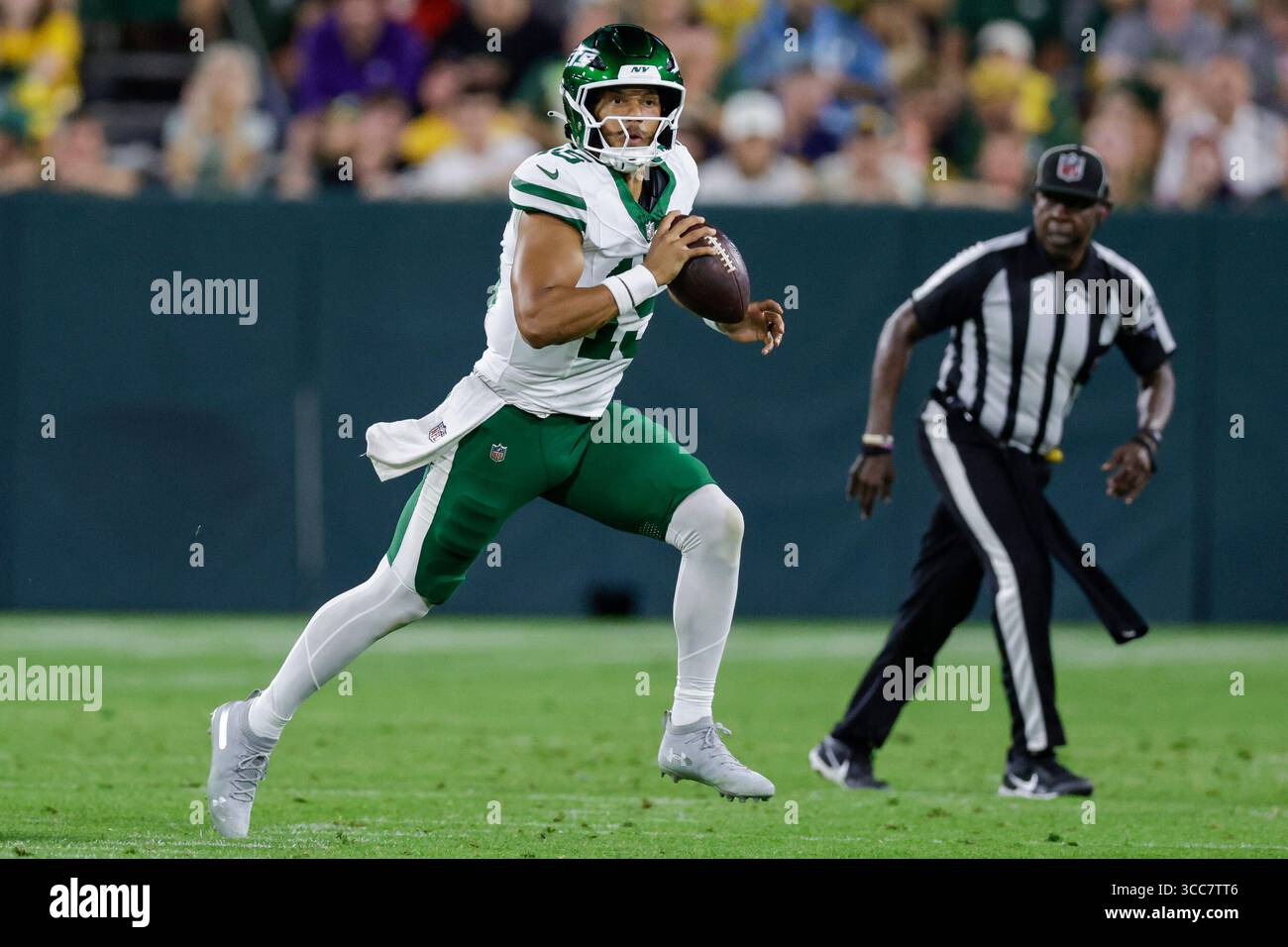 New York Jets quarterback Adrian Martinez (15) scrambles out of the ...