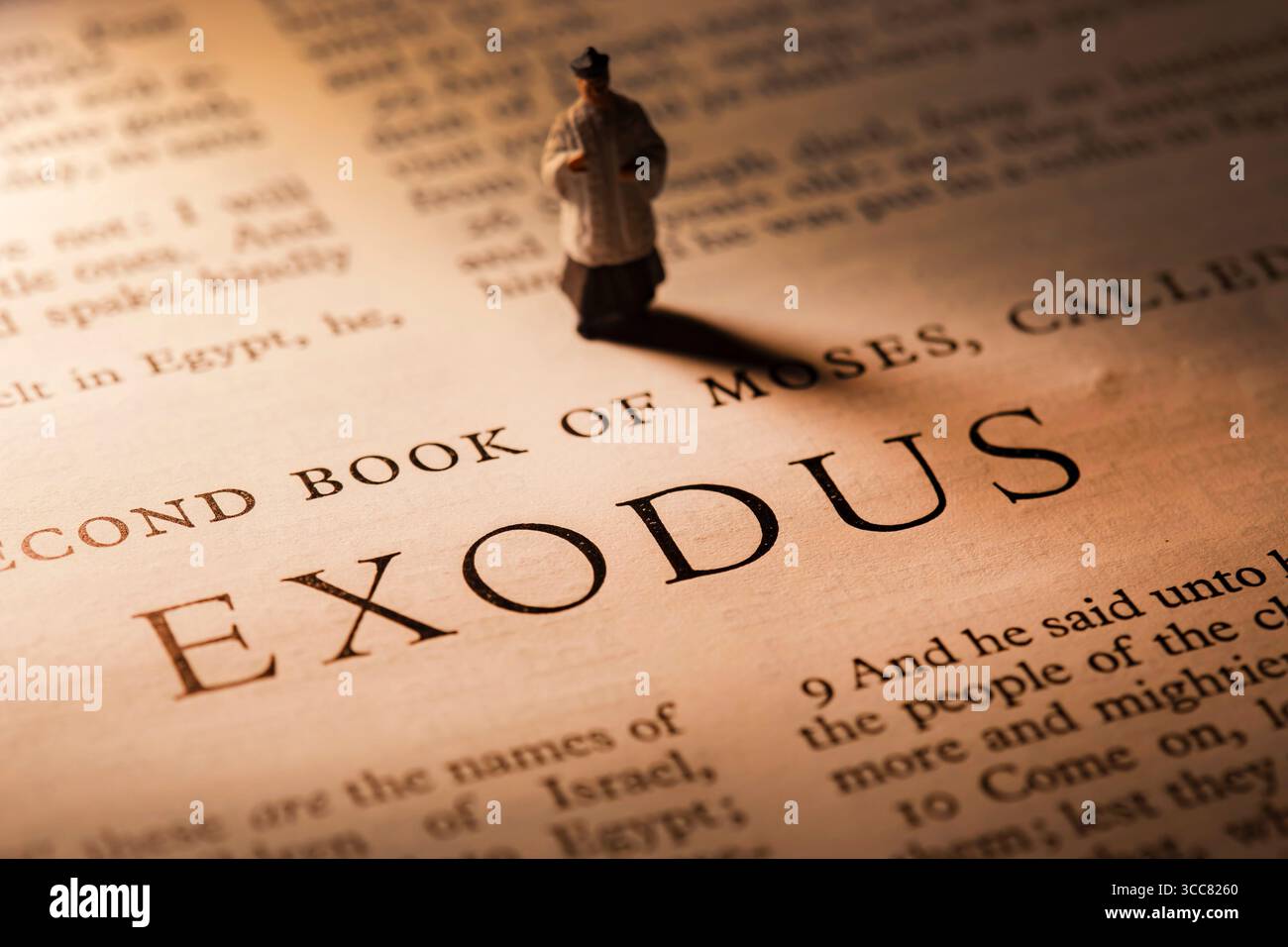 Exodus title bible page with a backlit miniature scale model priest ...