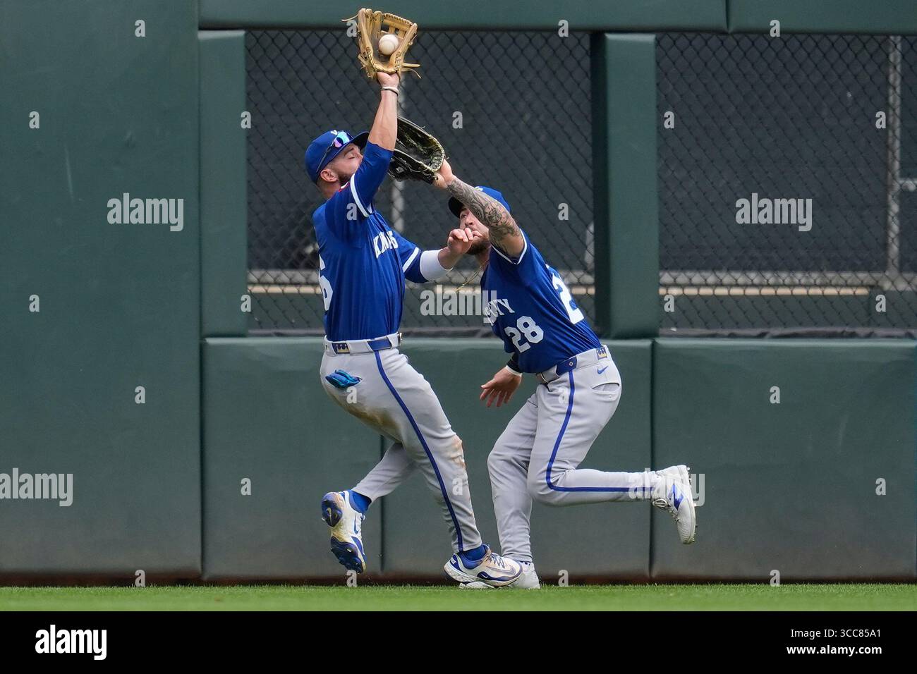 Kansas City Royals left fielder John Rave, left, catches a fly out hit ...