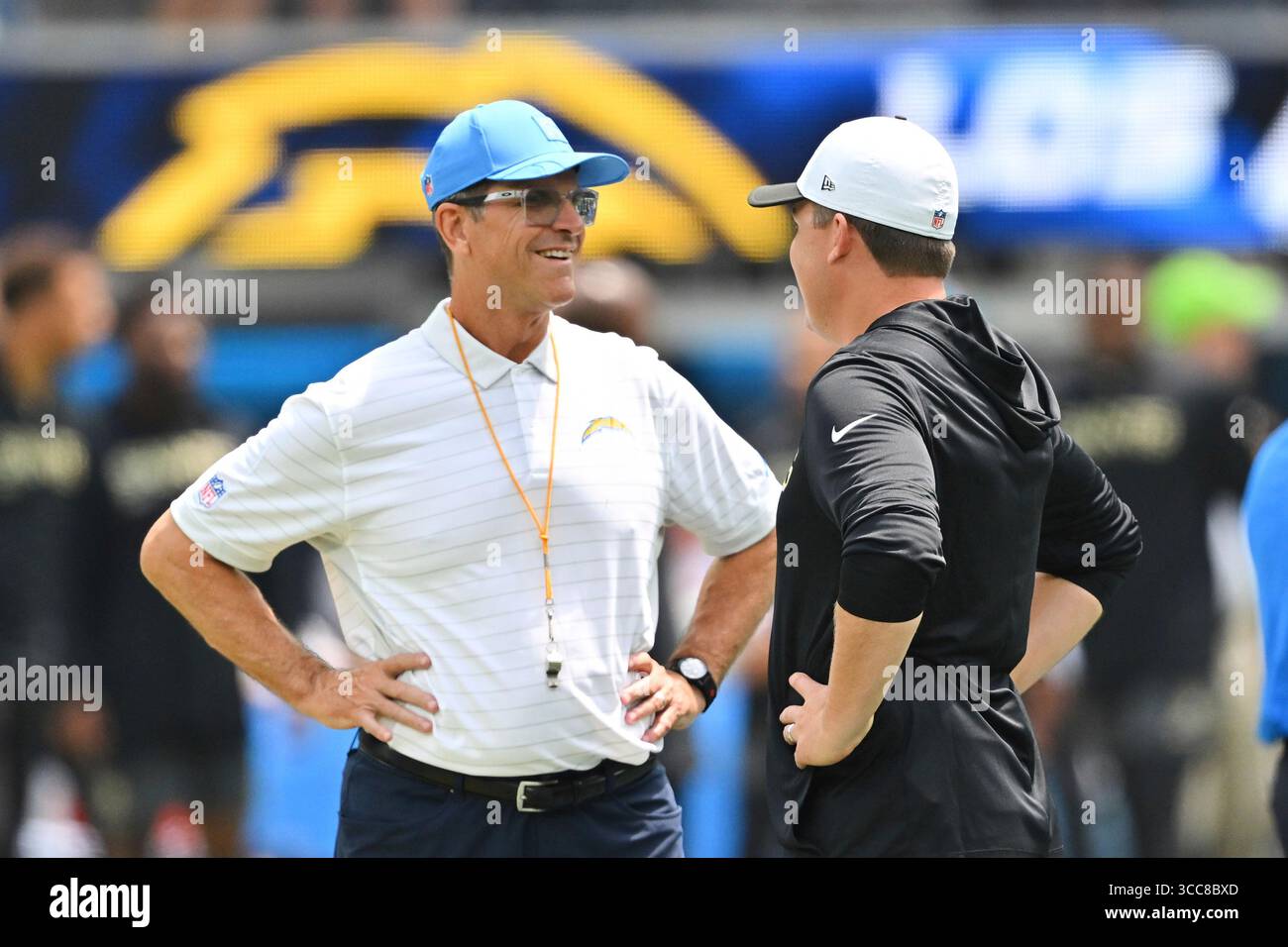 Los Angeles Chargers head coach Jim Harbaugh talks to New Orleans ...