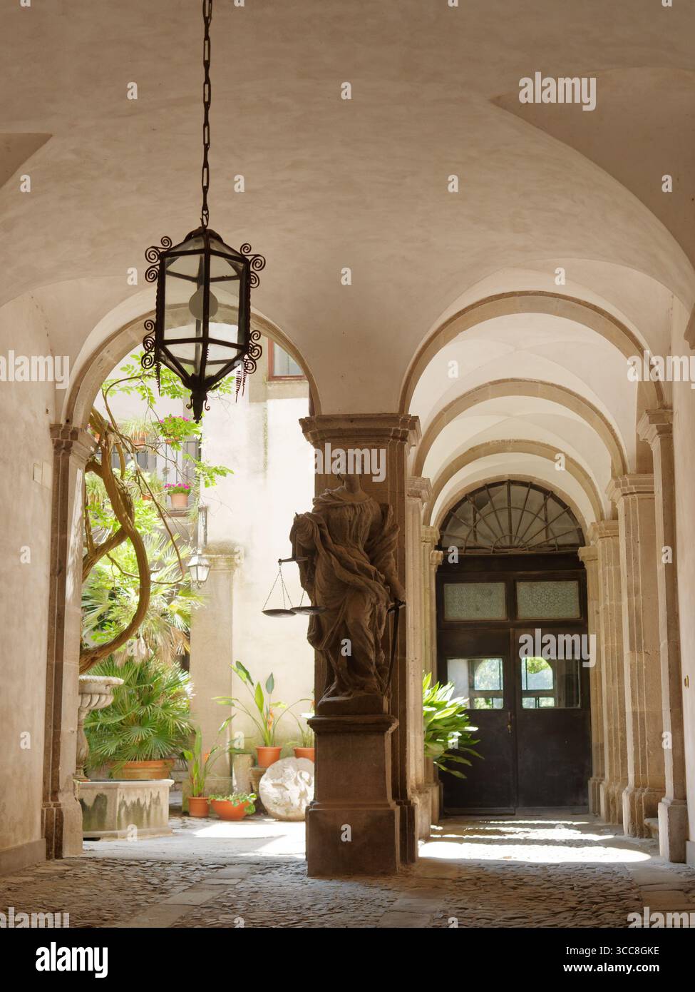 Elegant house forecourt with columns, arch and statue in the historic ...