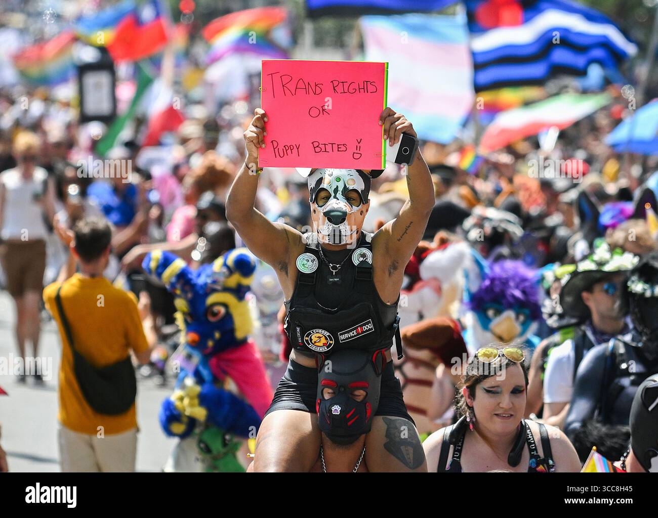 A person holds up a sign during the Pride parade in Montreal, Sunday ...