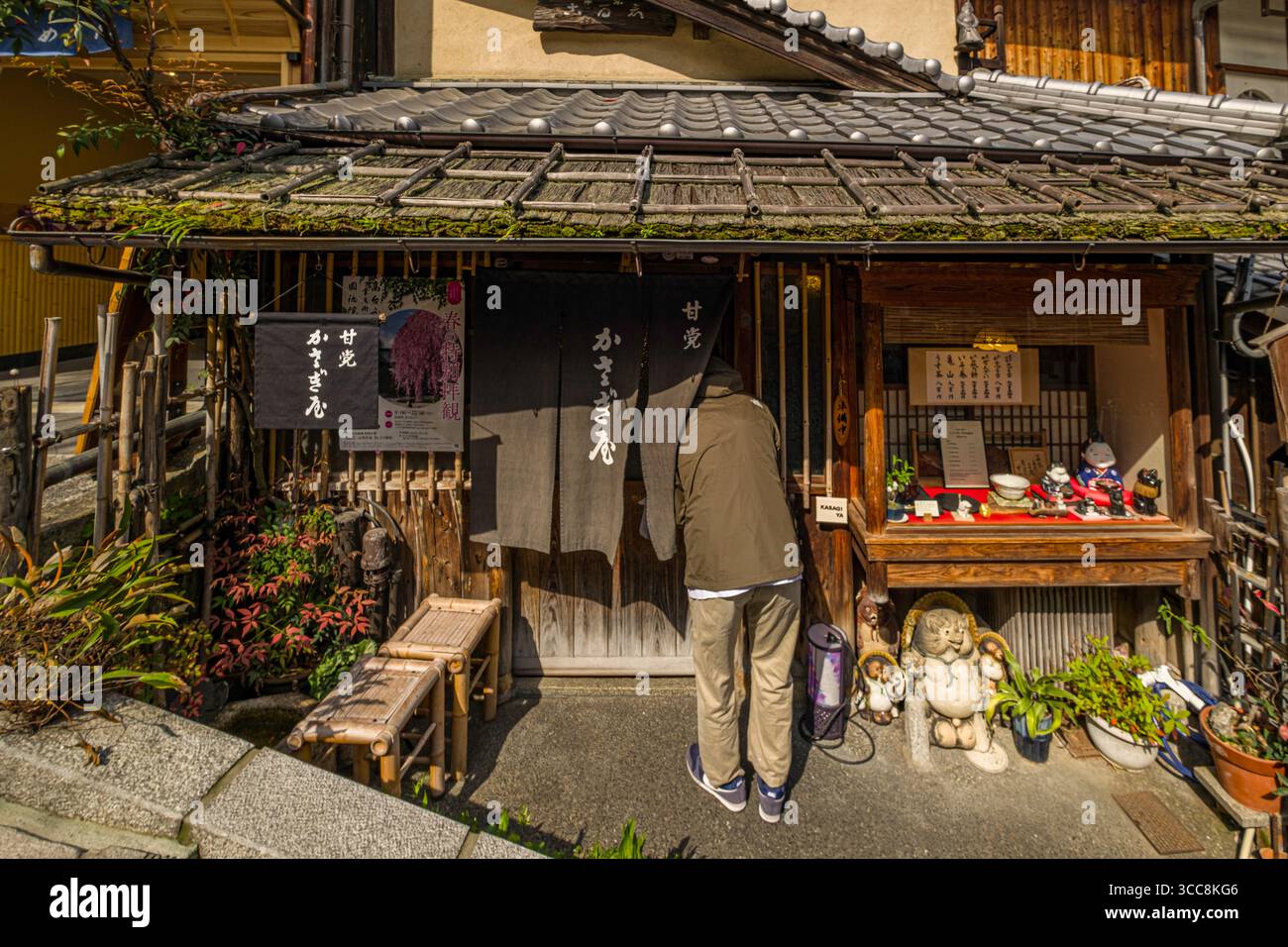 Back of man entering traditional Japanese shop, Masuyacho, Higashiyama ...