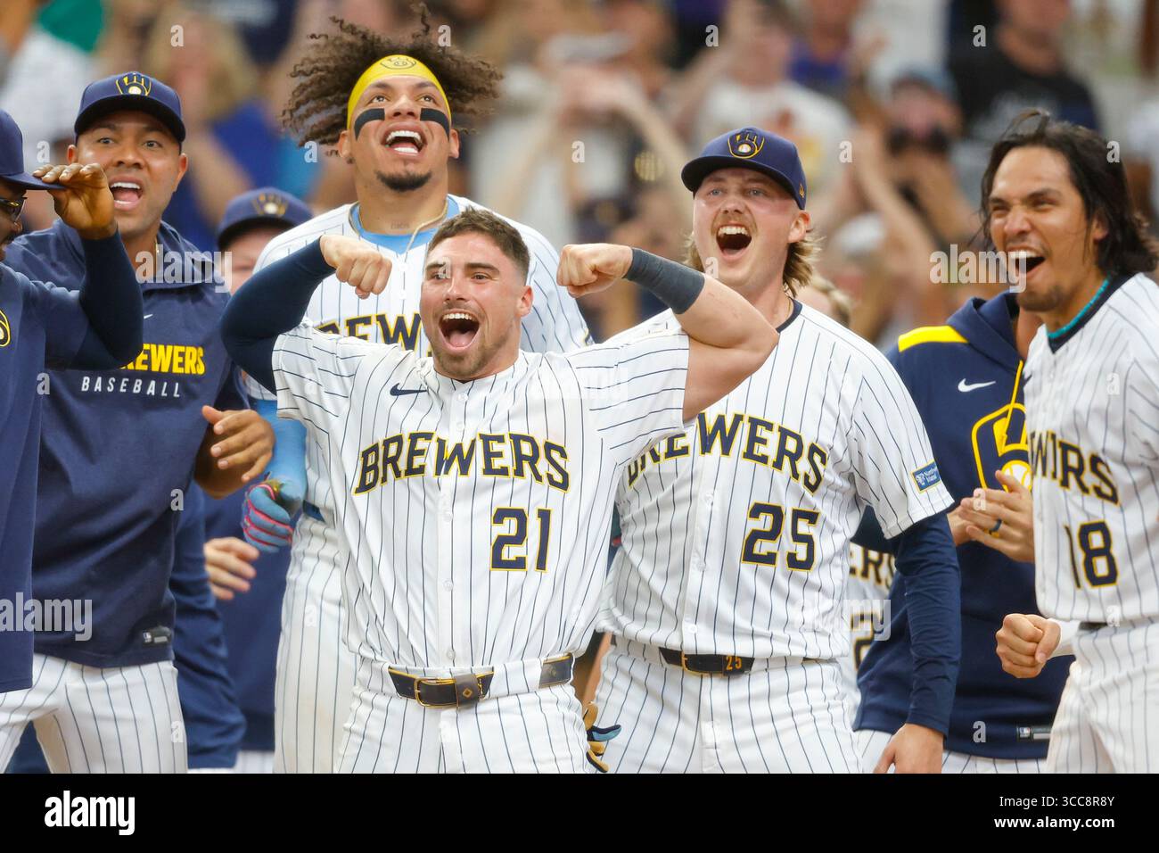 The Milwaukee Brewers wait for teammate Isaac Collins who hit a walk ...