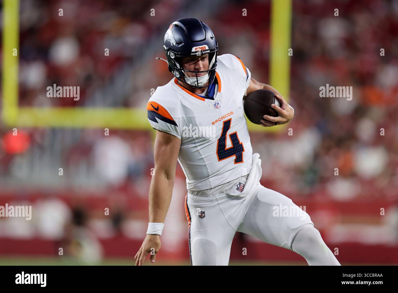 Denver Broncos quarterback Sam Ehlinger (4) runs during an NFL football ...