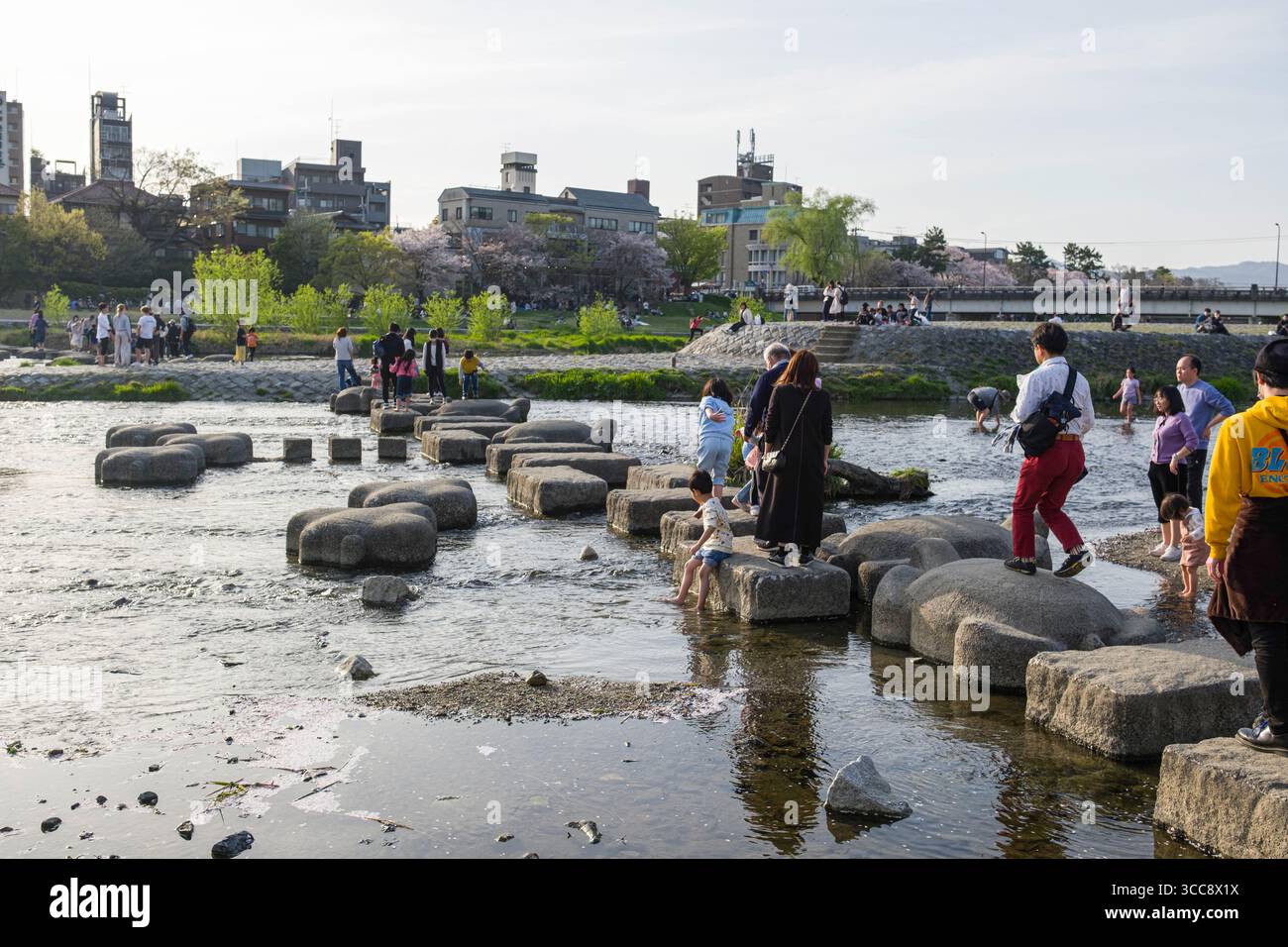 Adults and children testing their courage by crossing the Takano River ...