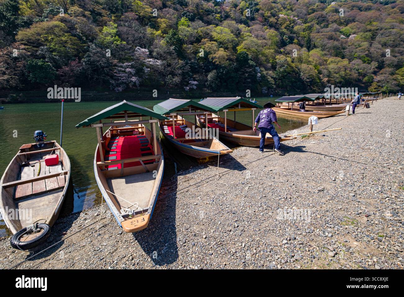 Traditional Japanese flat bottom tour boats on gravel beach on the ...