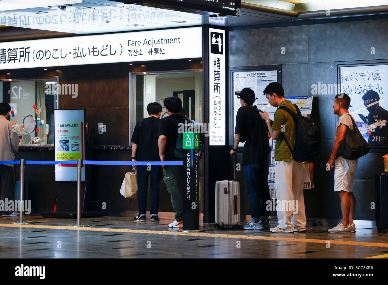 Travelers line up for refund tickets at JR Hakata Station on August 10 ...