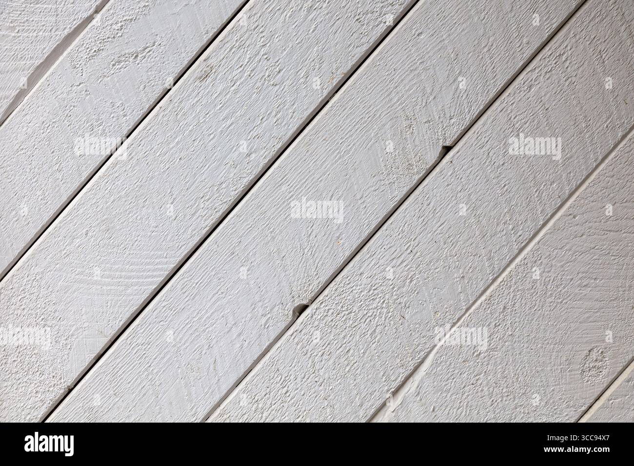 White painted wooden planks arranged diagonally showcase natural grain ...