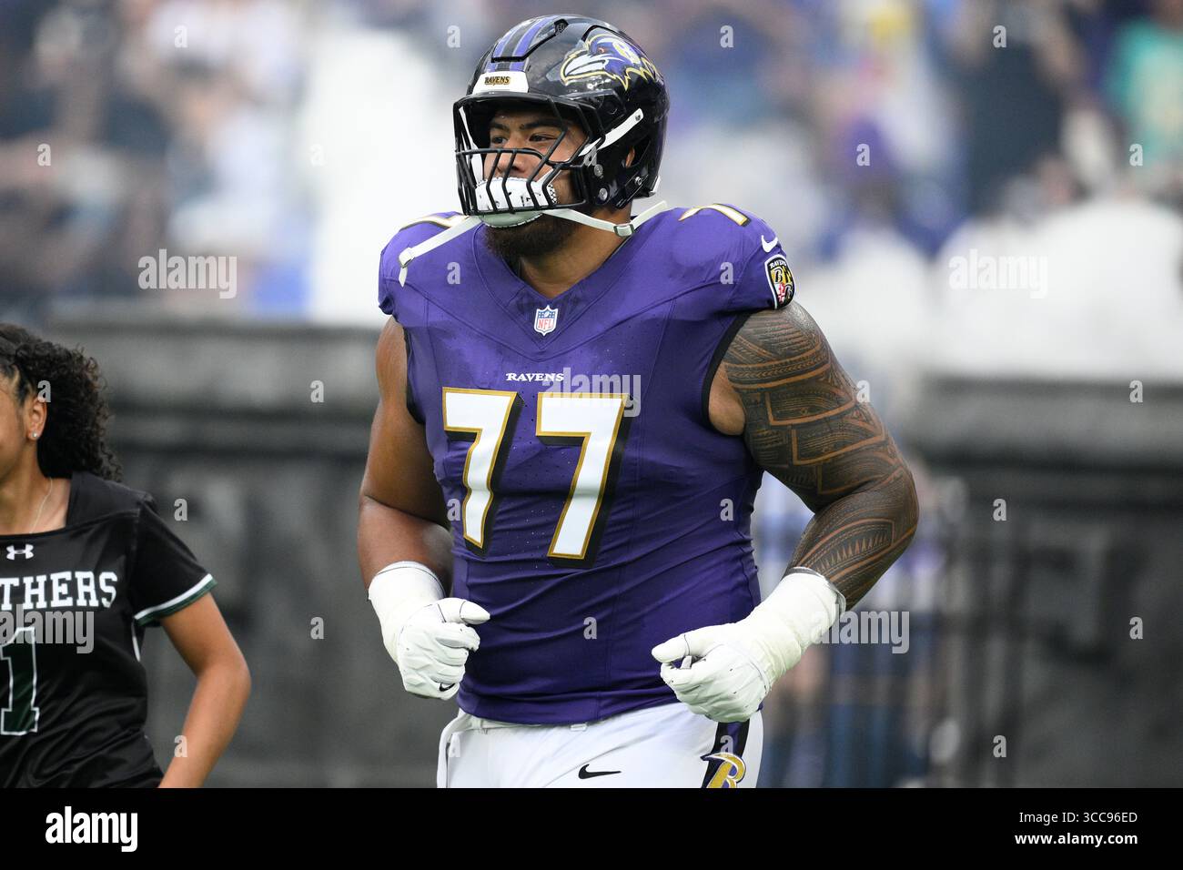 Baltimore Ravens guard Daniel Faalele (77) takes to the field before an ...