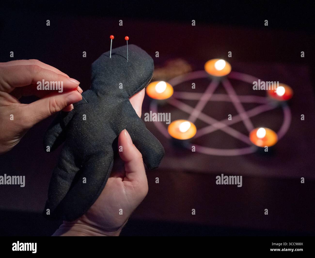 Woman sticking pins voodoo doll hi-res stock photography and images - Alamy