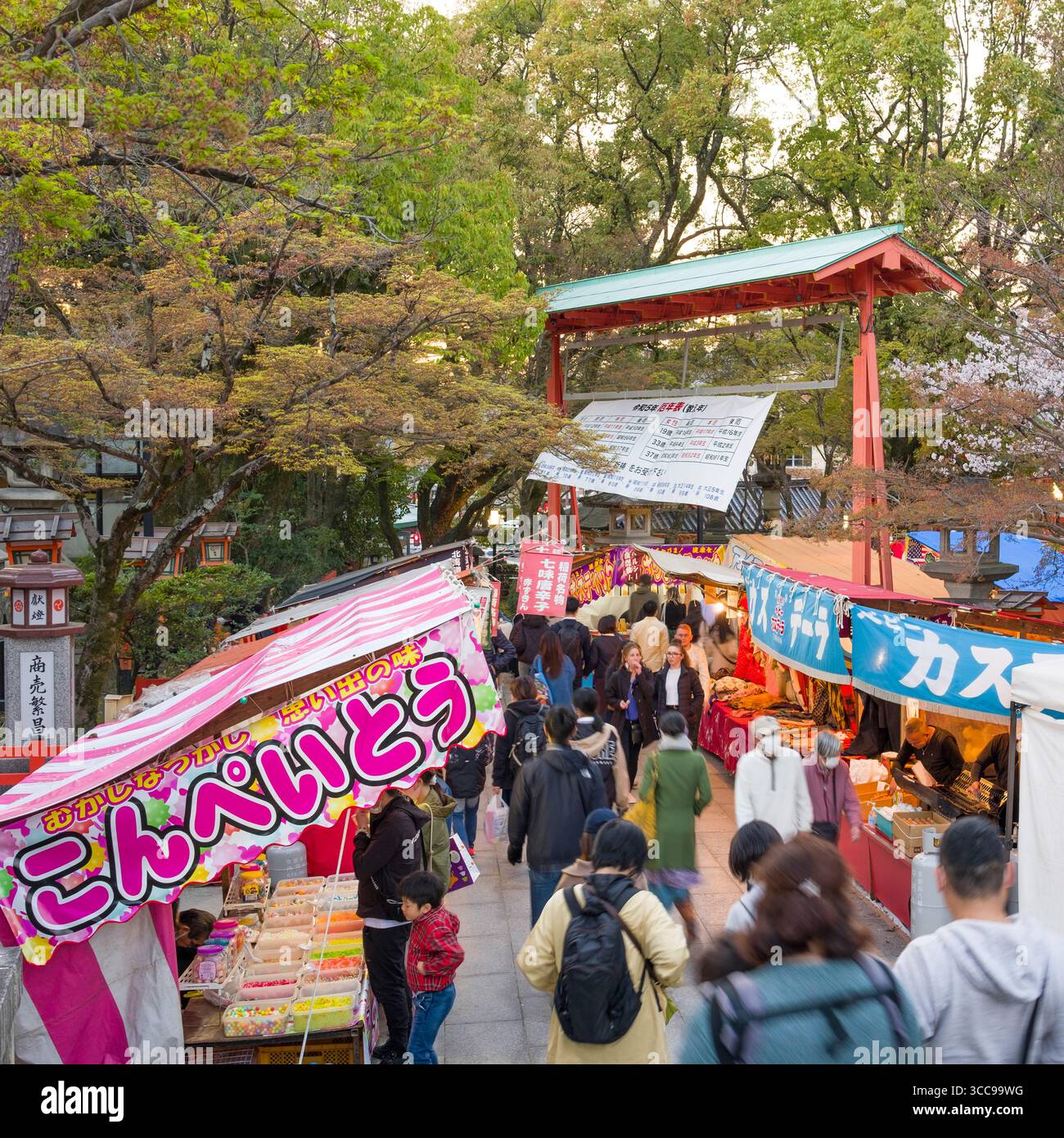 Vendors selling food from colorful temporary stalls during Hanami ...