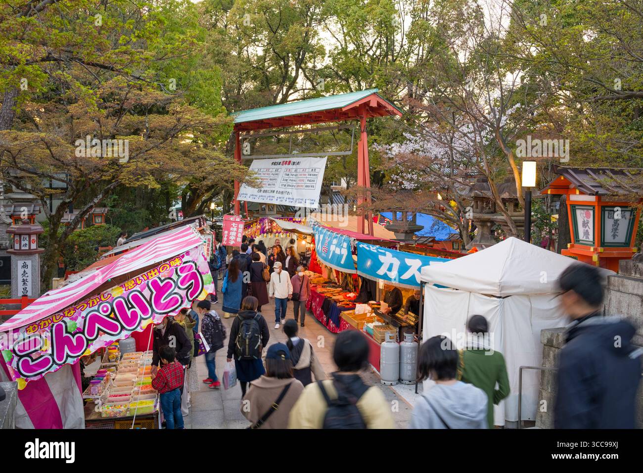Vendors selling food from colorful temporary stalls during Hanami ...