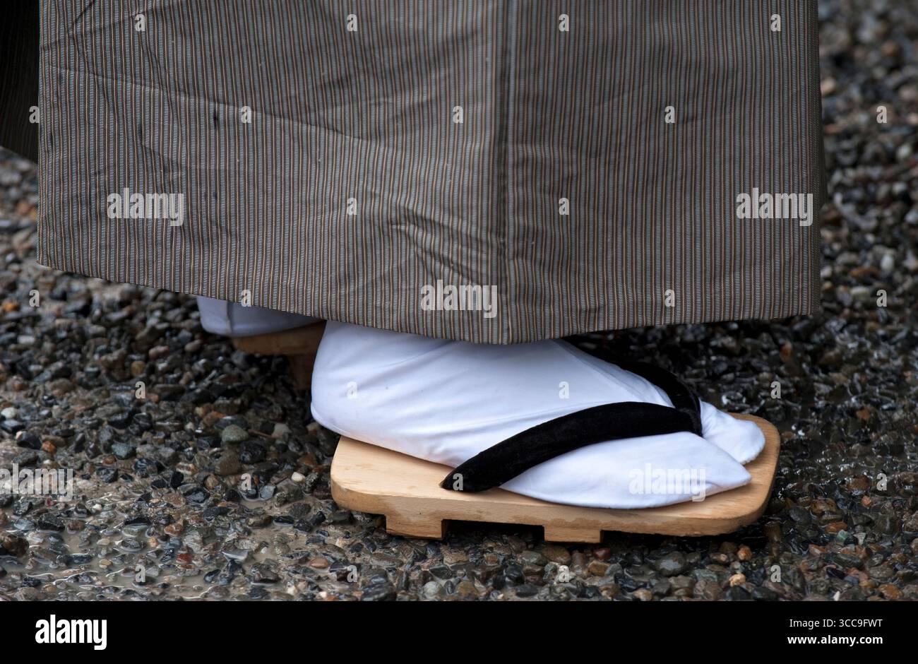 A Japanese man in kimono wearing traditional wooden geta (下駄) sandals ...