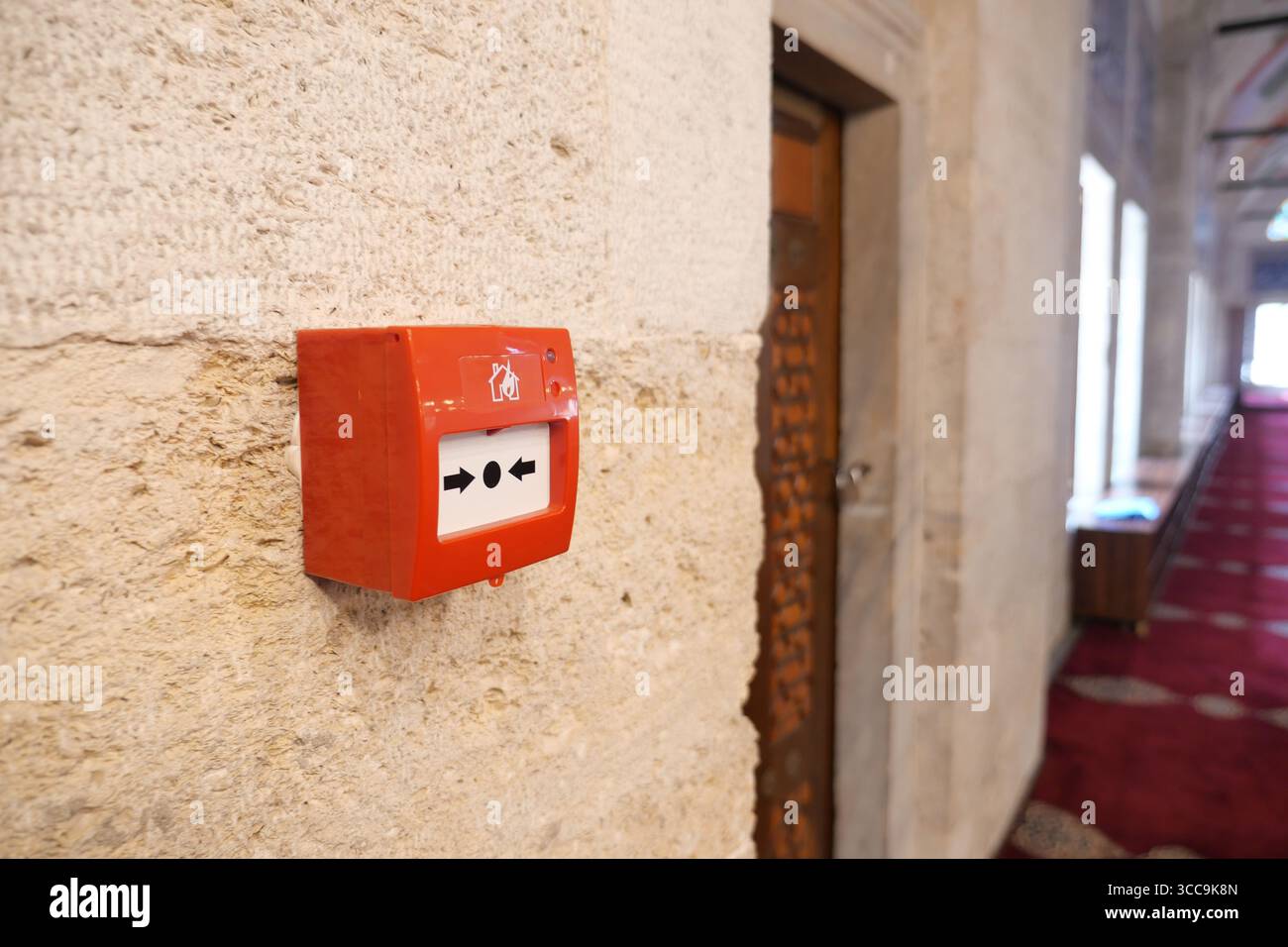 Fire alarm box mounted in a historic building hallway Stock Photo - Alamy