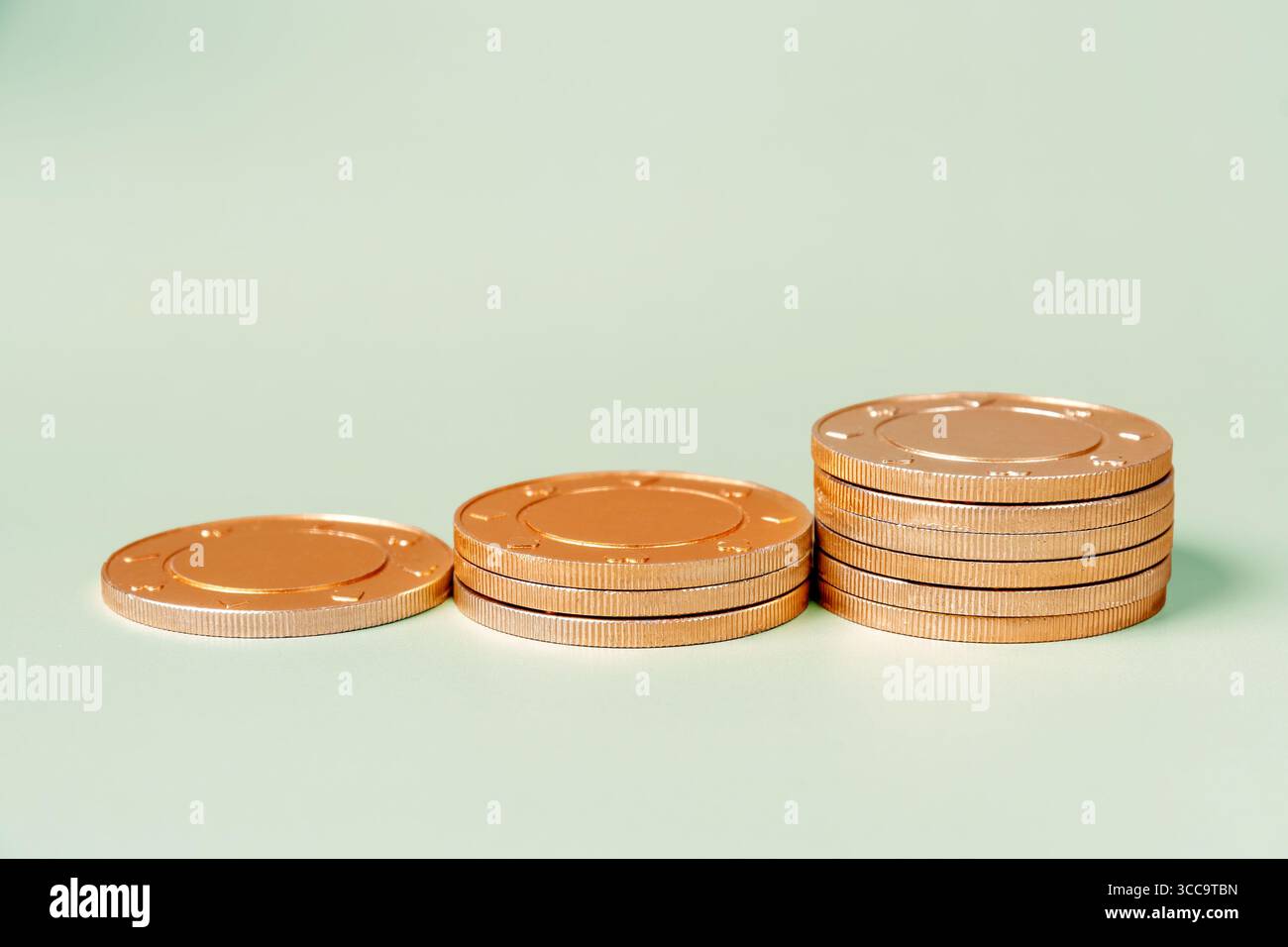 Stacks of golden coins lined up by height from left to right. The coins ...