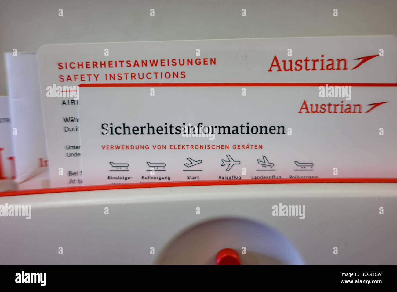 Airline safety instructions card in seat pocket on Austrian Airlines ...